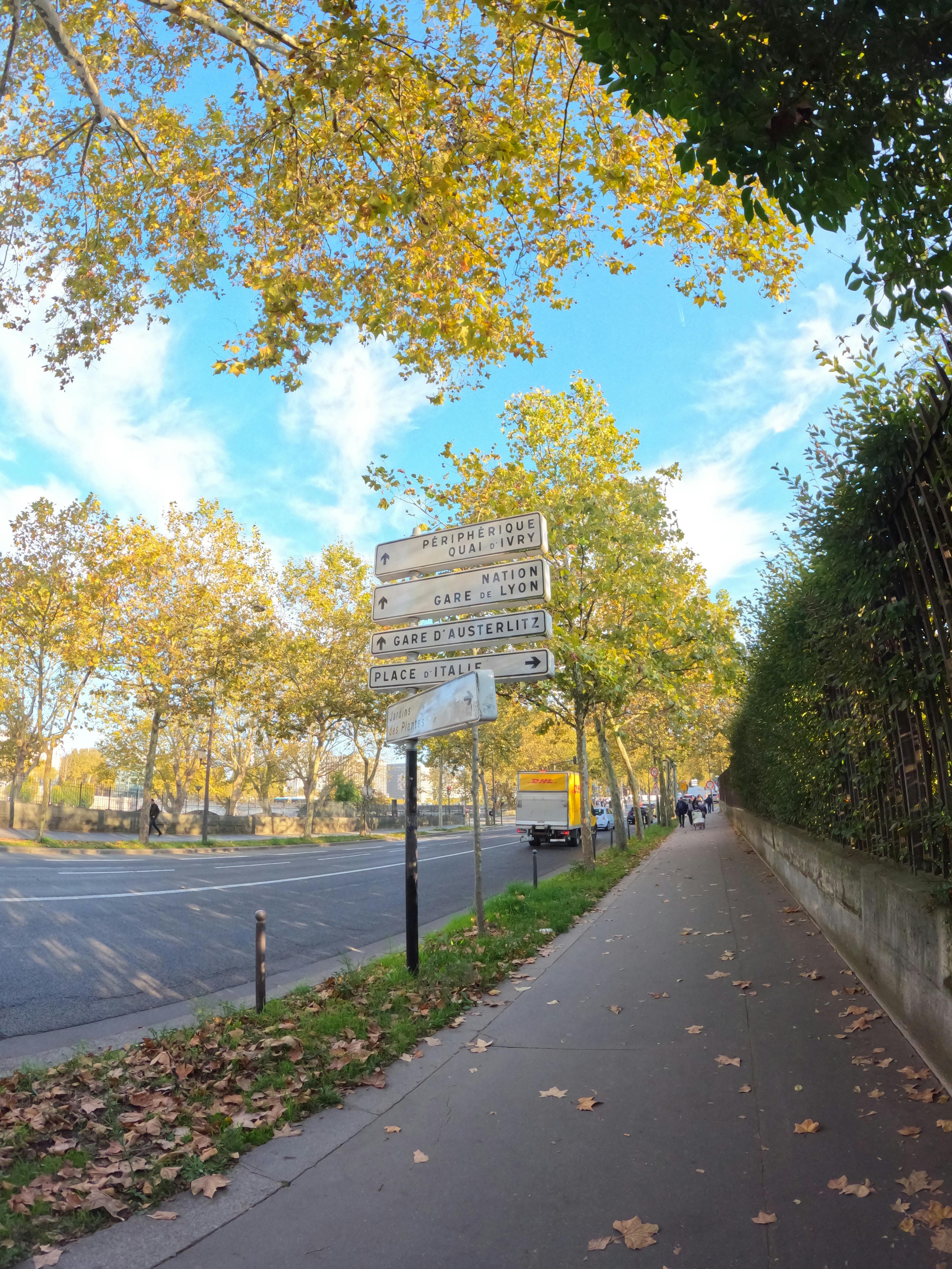 Autumn Paris Street with Directional Signs · Free Stock Photo