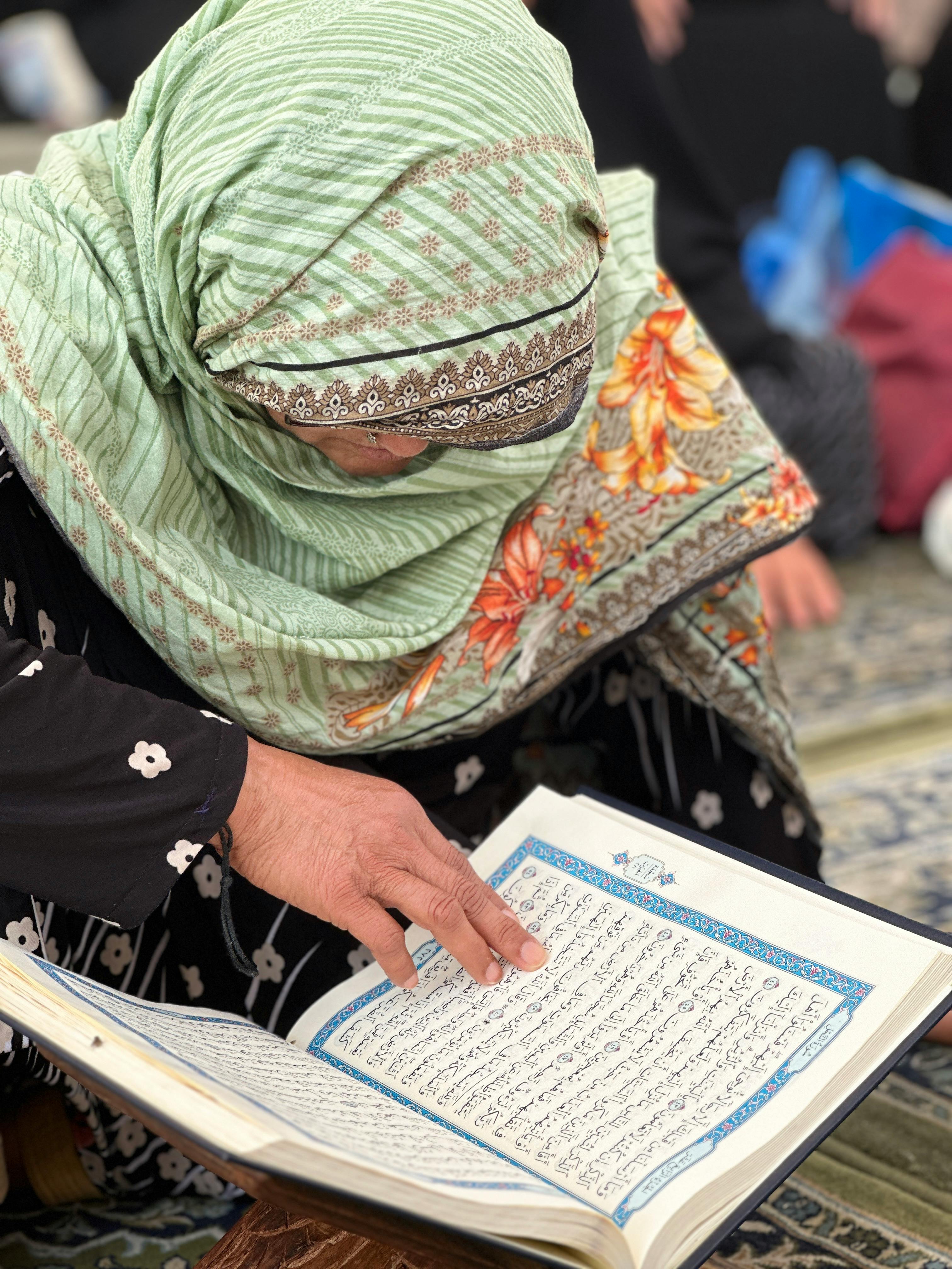 Middle Eastern Woman Reading Quran in Medina · Free Stock Photo