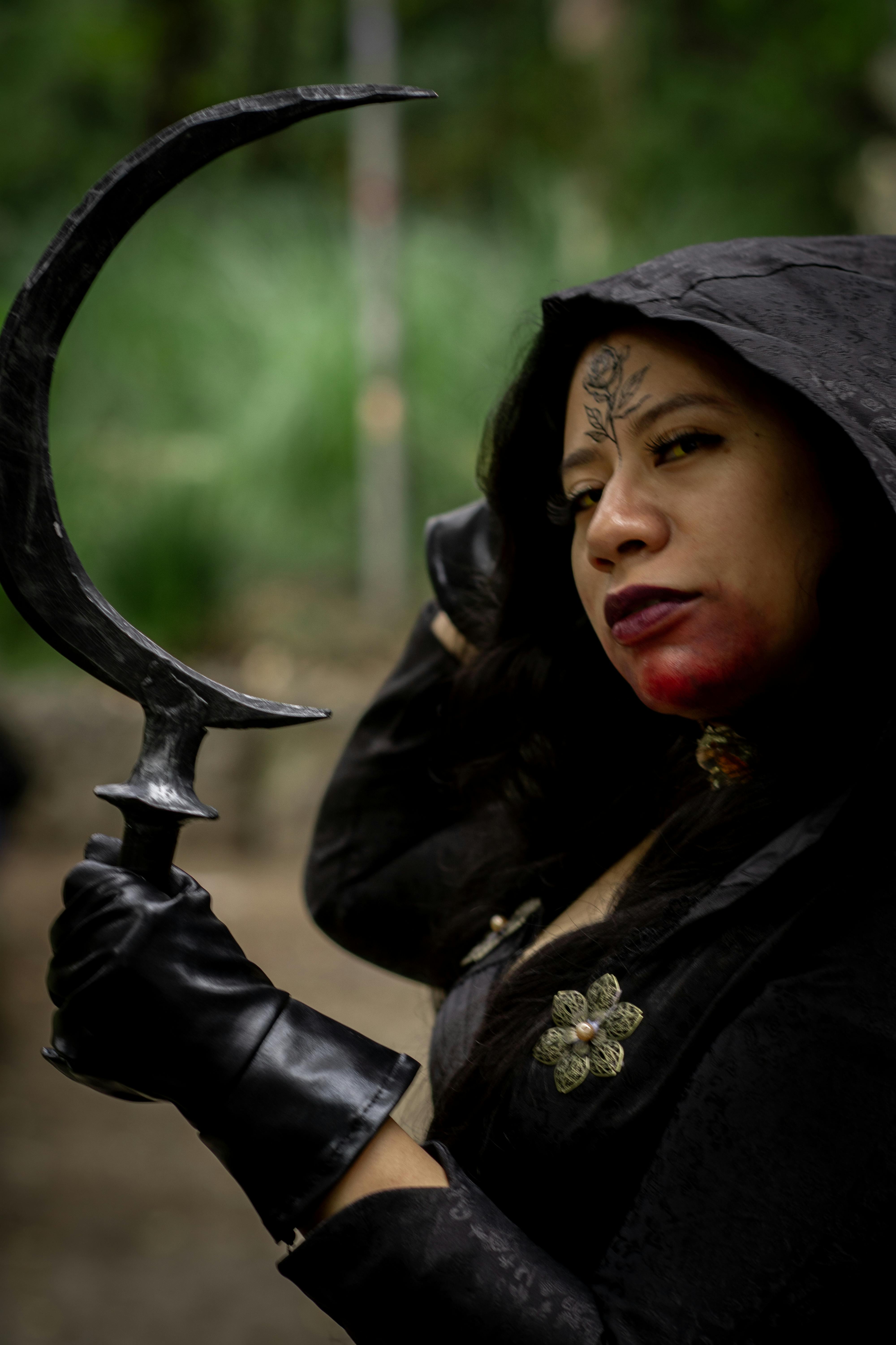 Mysterious Cosplay with Scythe in Forest Setting · Free Stock Photo