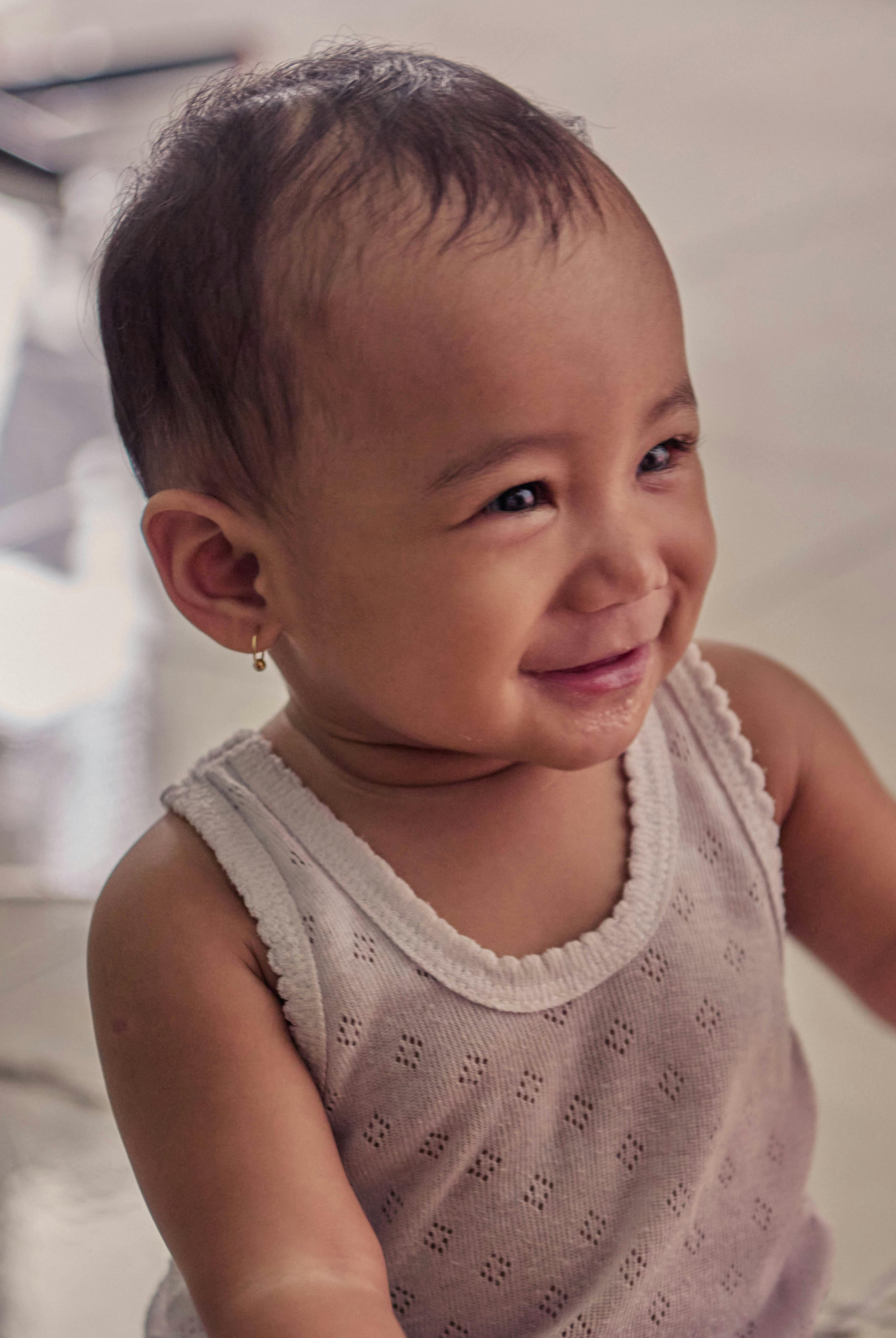 Adorable Smiling Baby in Indoor Setting · Free Stock Photo