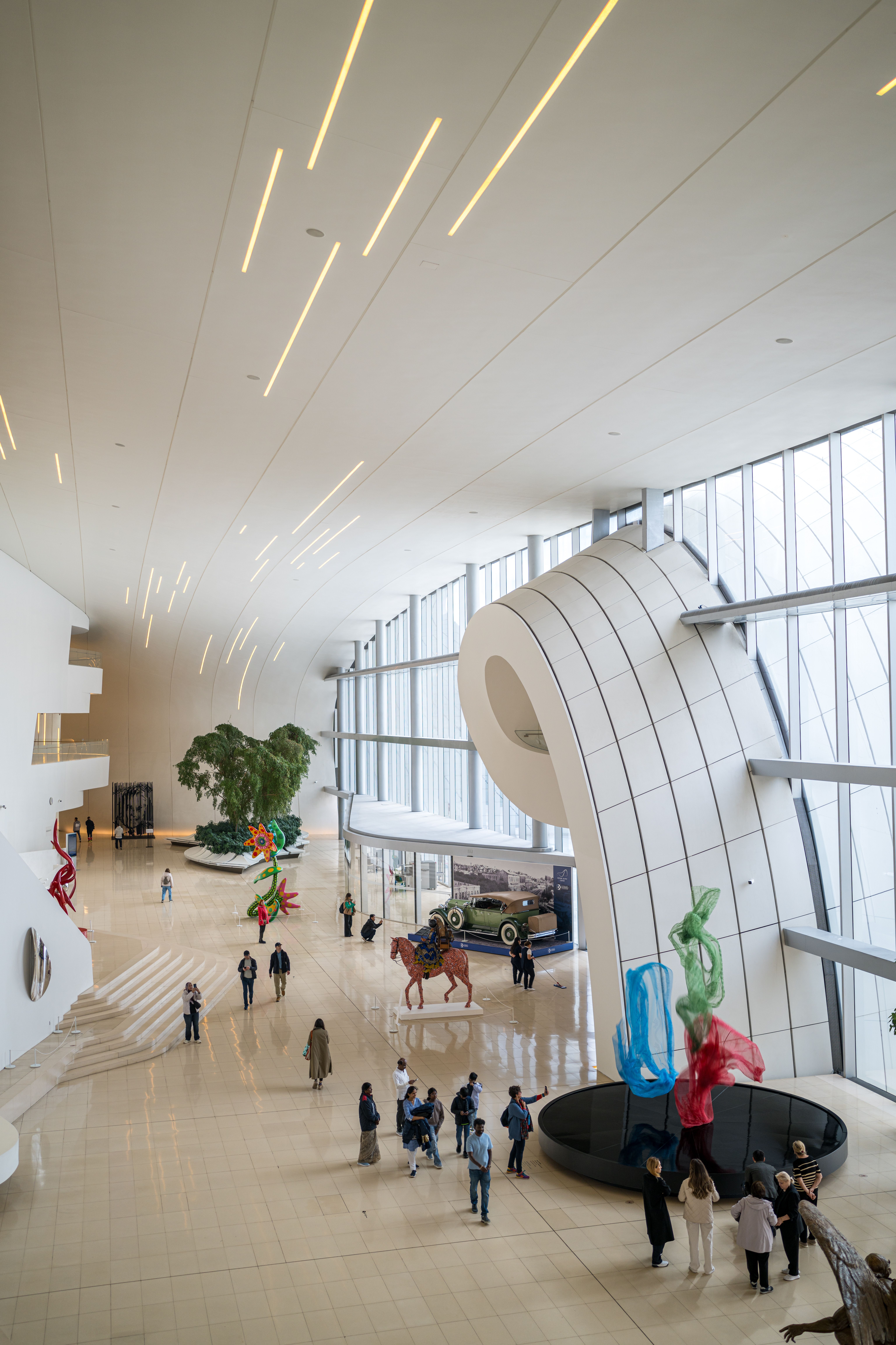 Modern Indoor Space with Sculptures and Visitors · Free Stock Photo