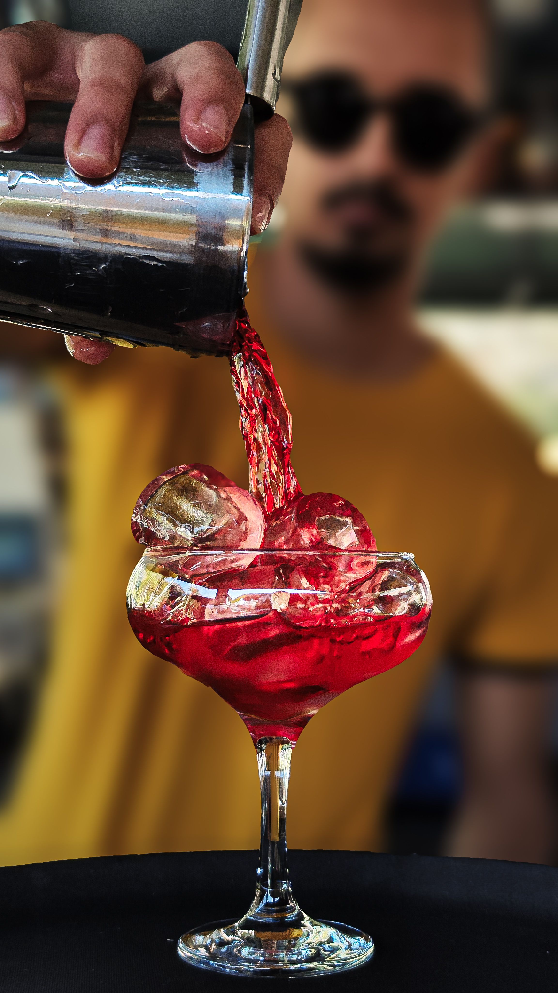 Bartender Pouring Red Cocktail into a Glass · Free Stock Photo