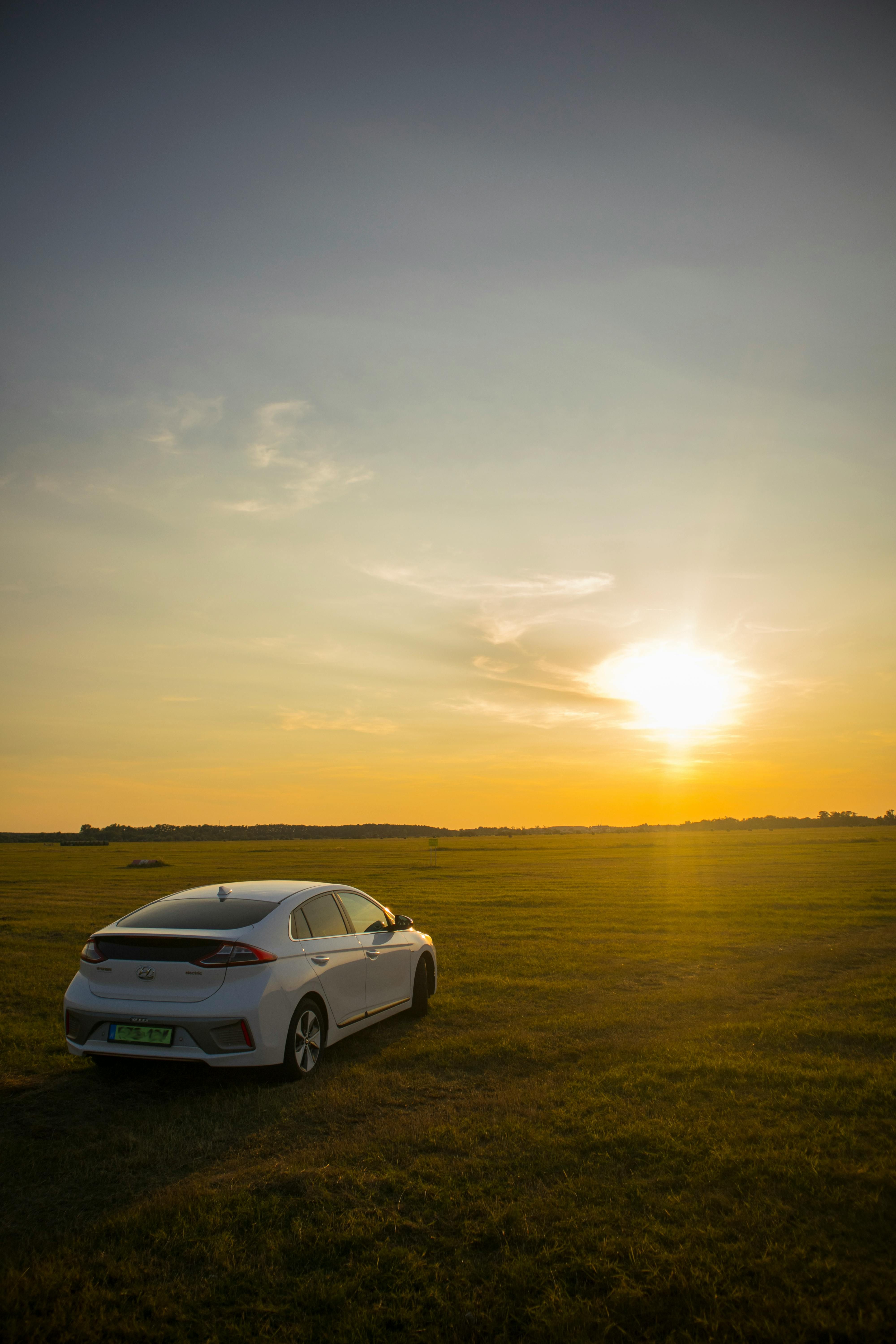 White Car in Open Field at Sunset · Free Stock Photo