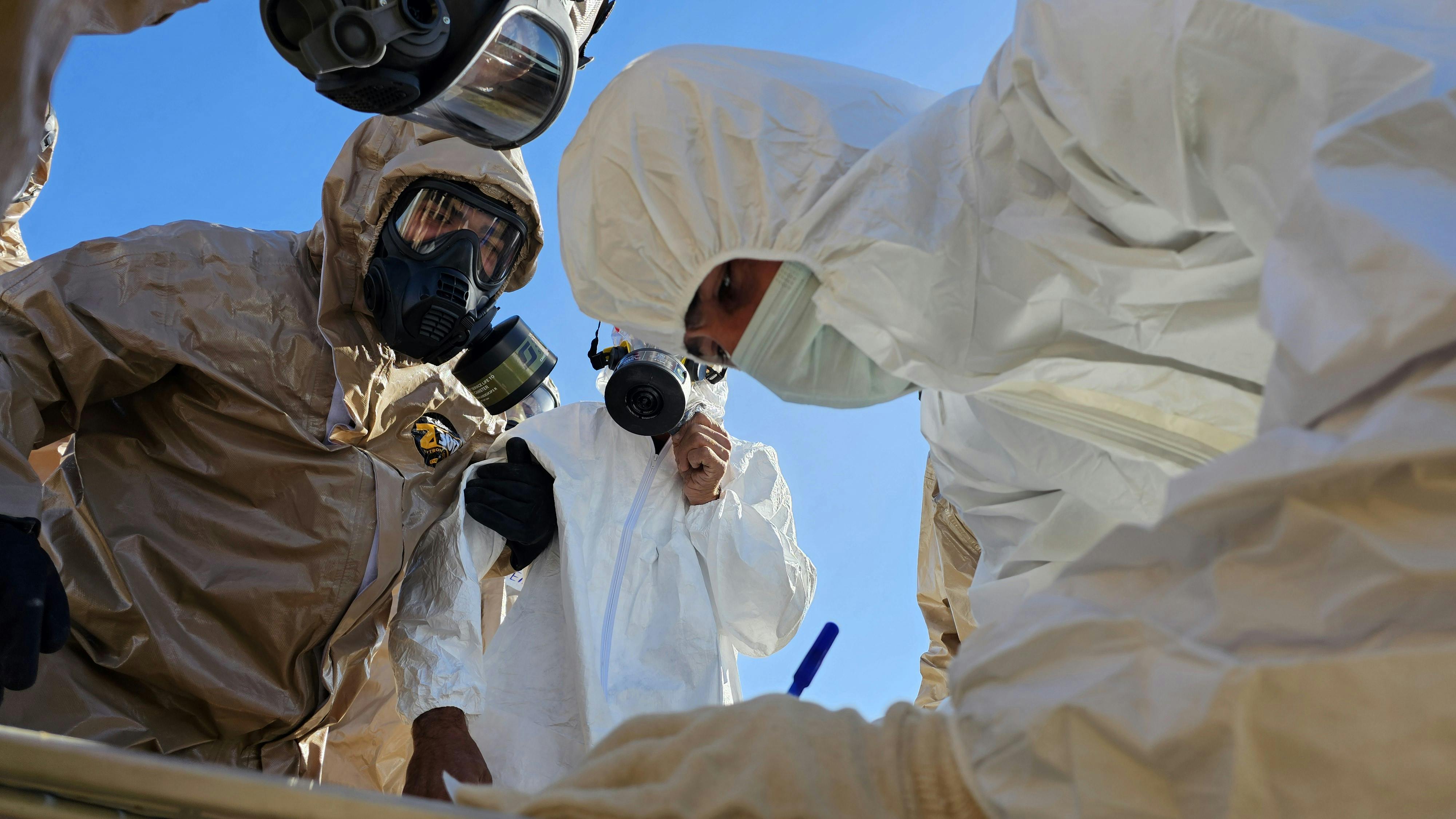 Technicians in Hazmat Suits Conducting Inspection · Free Stock Photo