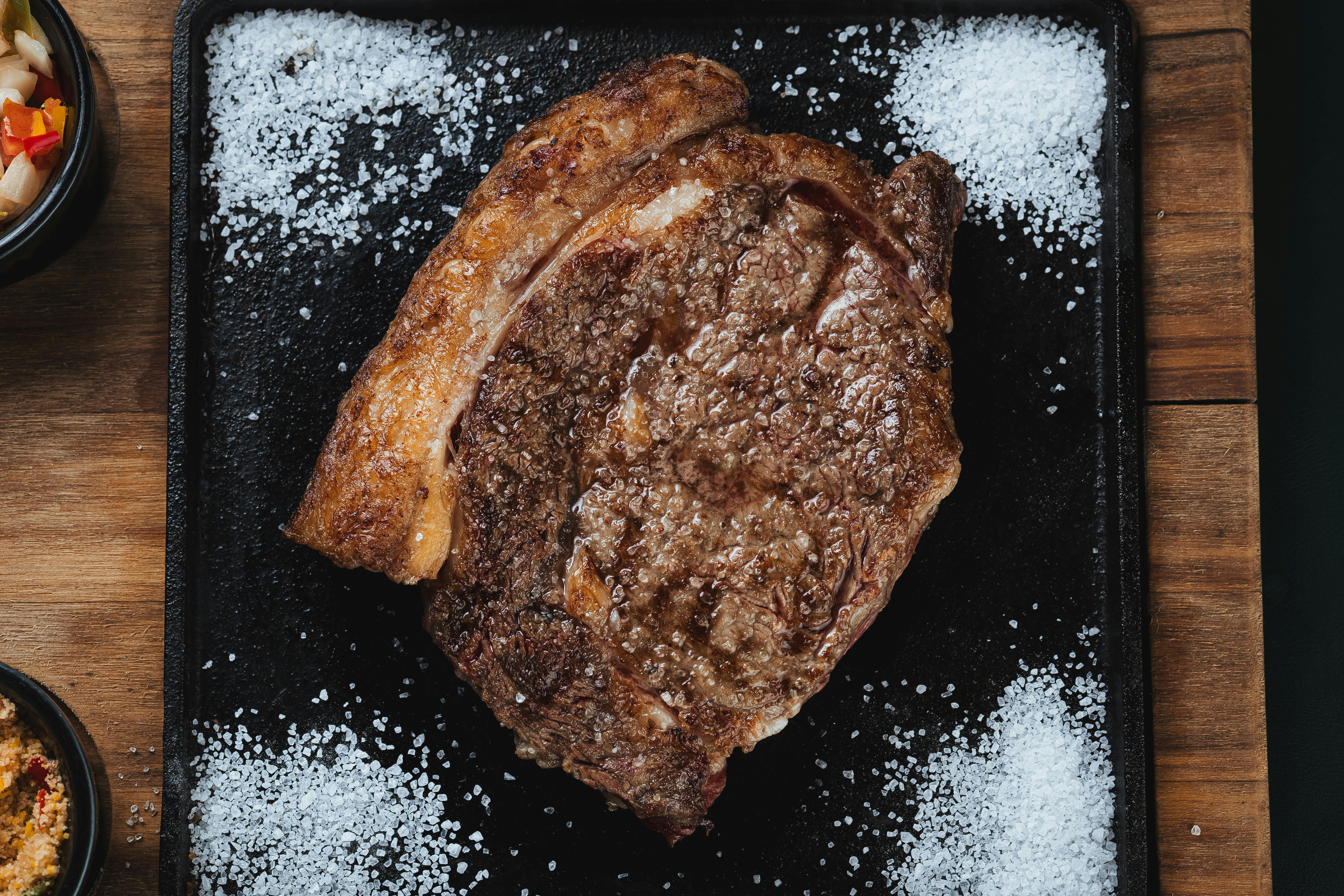 Delicious Grilled Ribeye Steak on Cutting Board · Free Stock Photo
