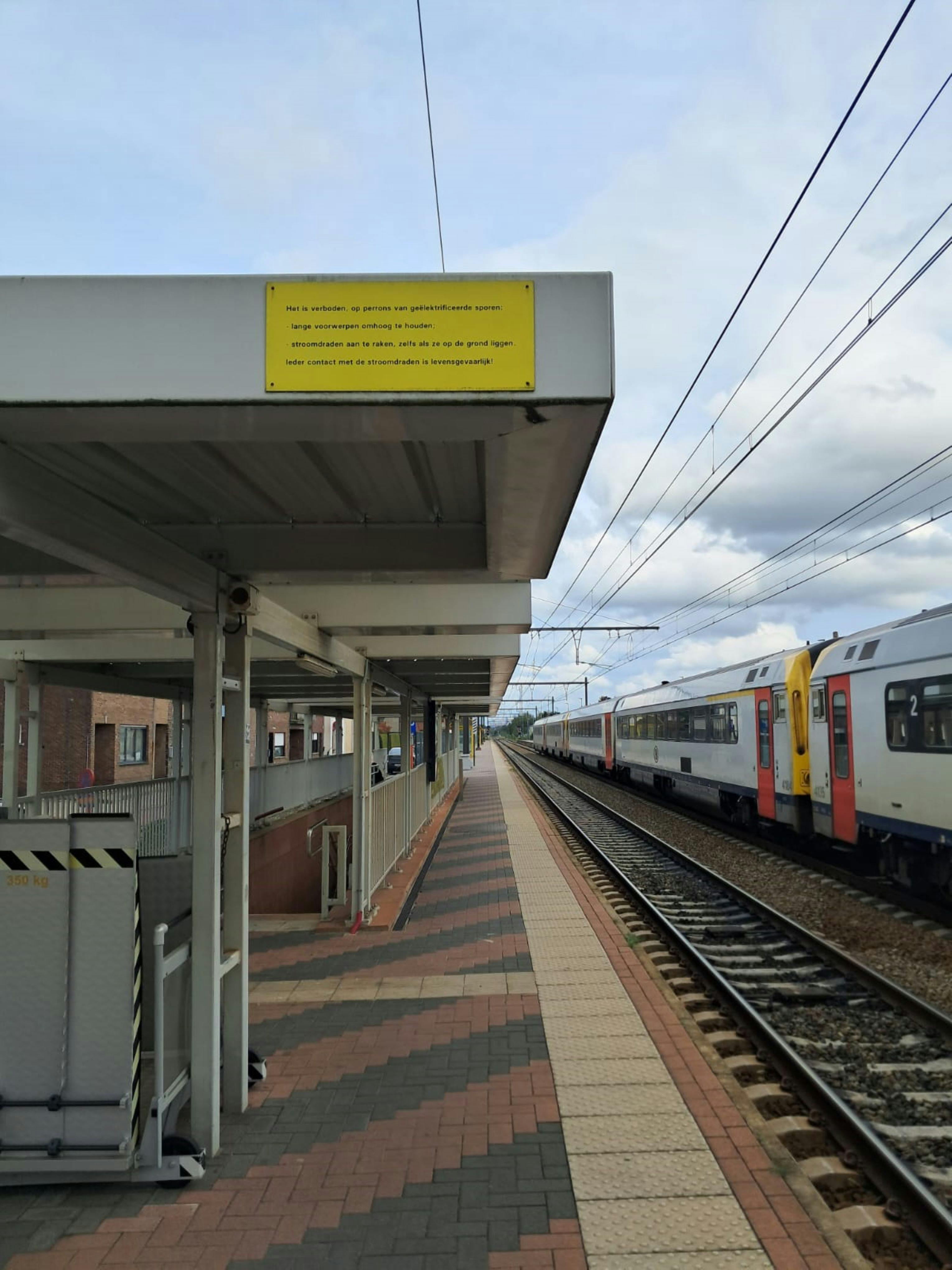 Empty train station platform with departing train · Free Stock Photo