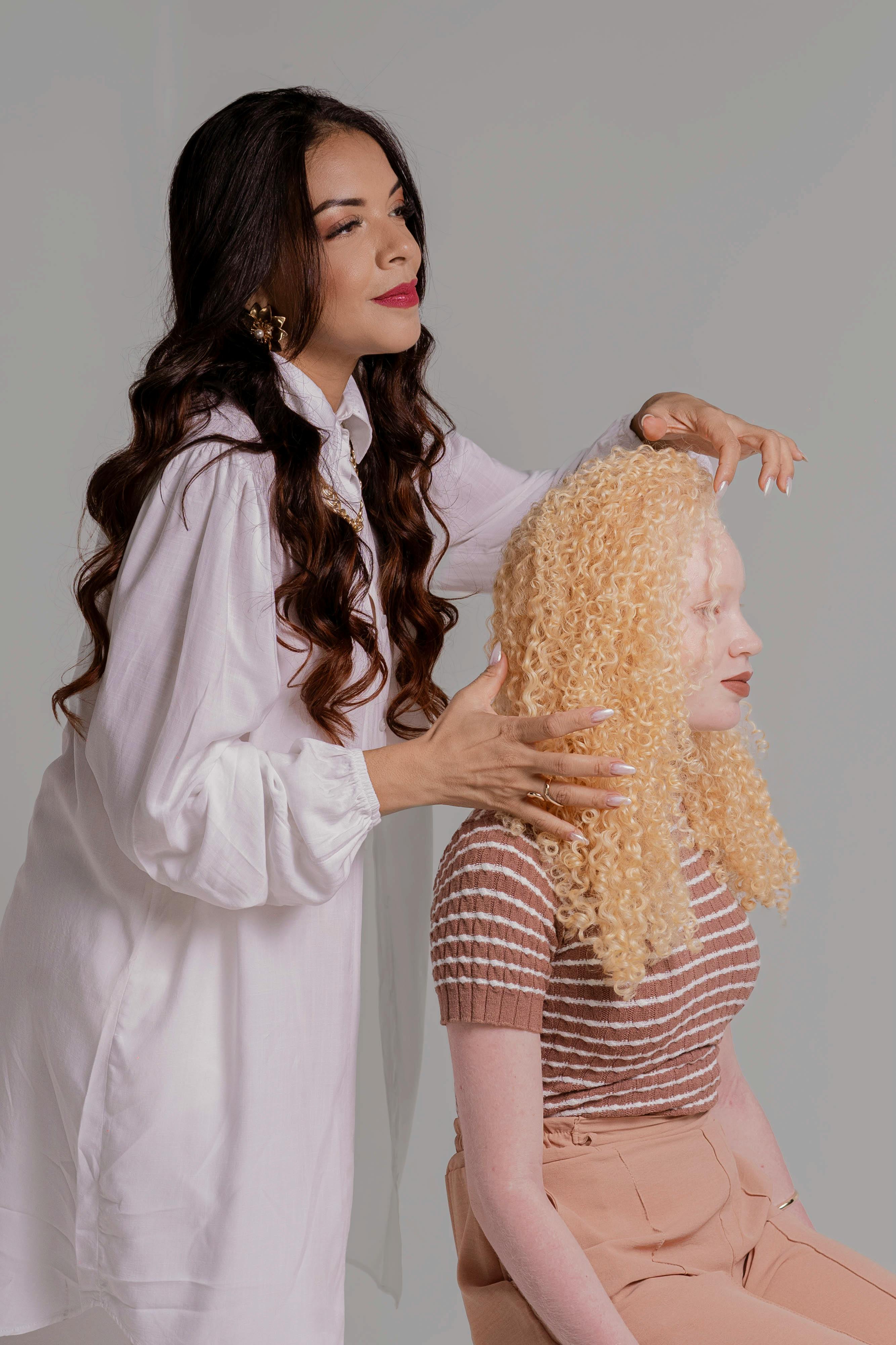 Professional Hair Stylist with Diverse Models · Free Stock Photo