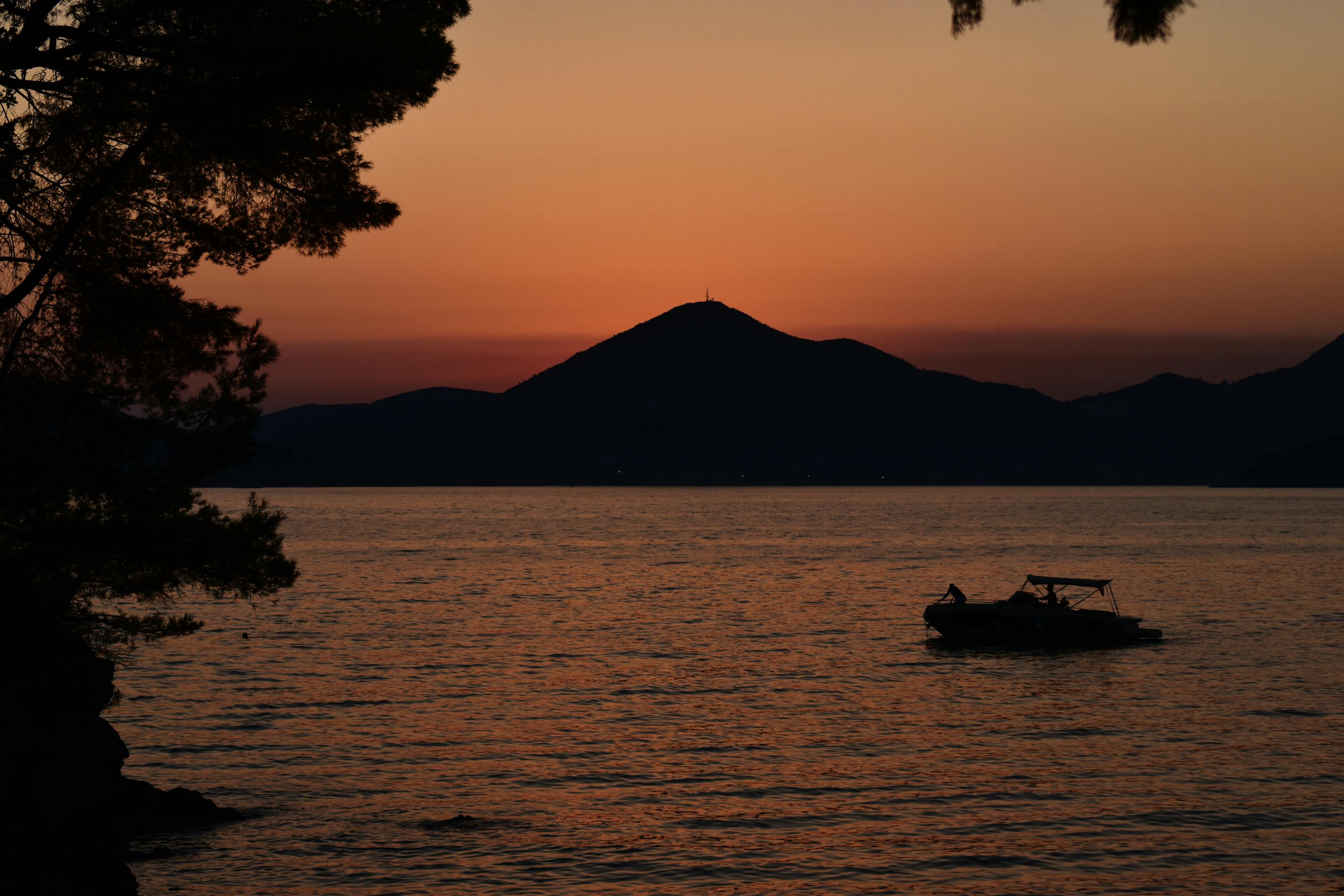 Sunset Over Montenegrin Sea with Boat Silhouette · Free Stock Photo