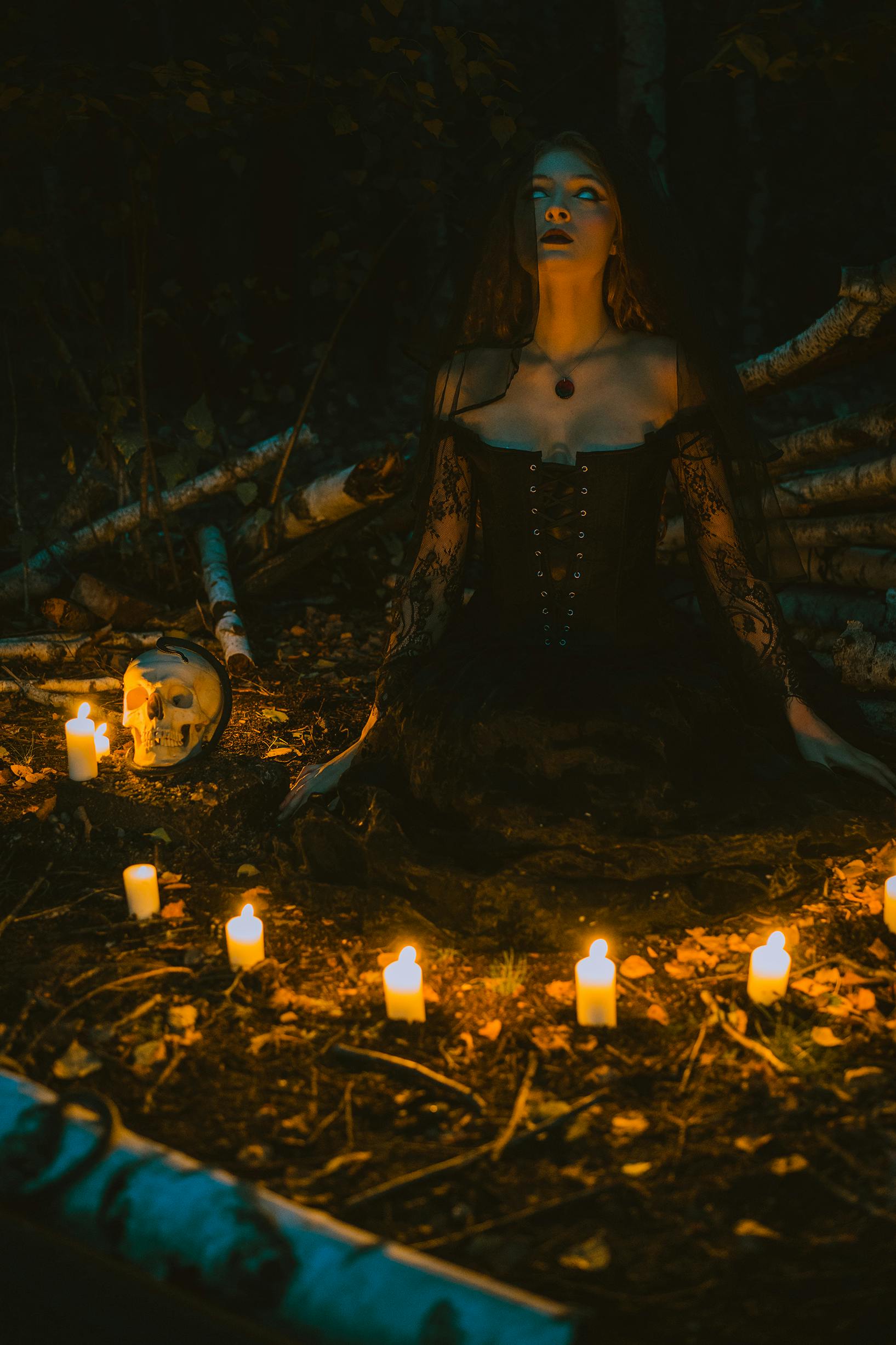 Spooky witch among candles during ritual · Free Stock Photo