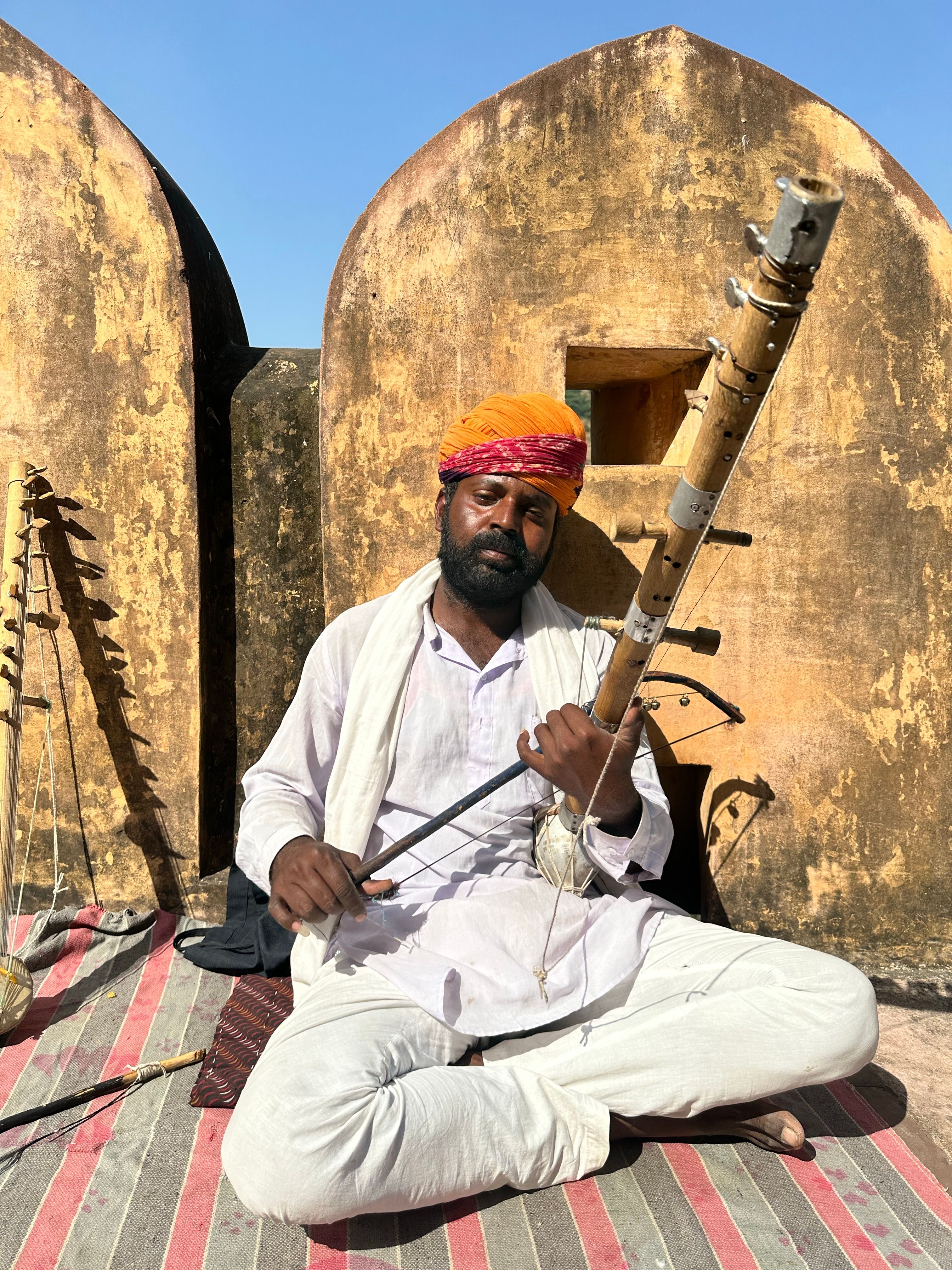 Rajasthani musician playing traditional instrument outdoors · Free ...