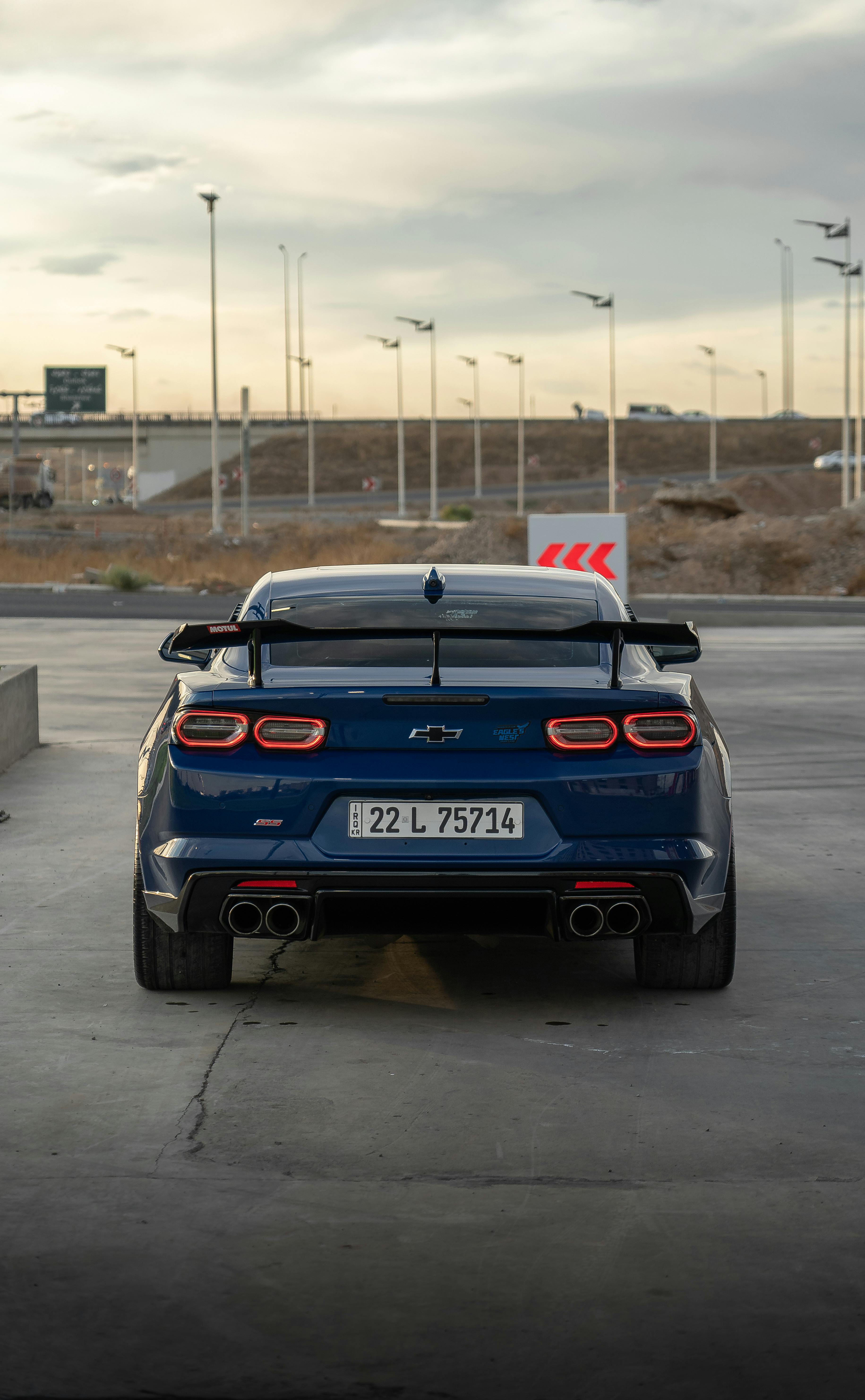 Rear View of a Chevrolet Camaro on Empty Road · Free Stock Photo