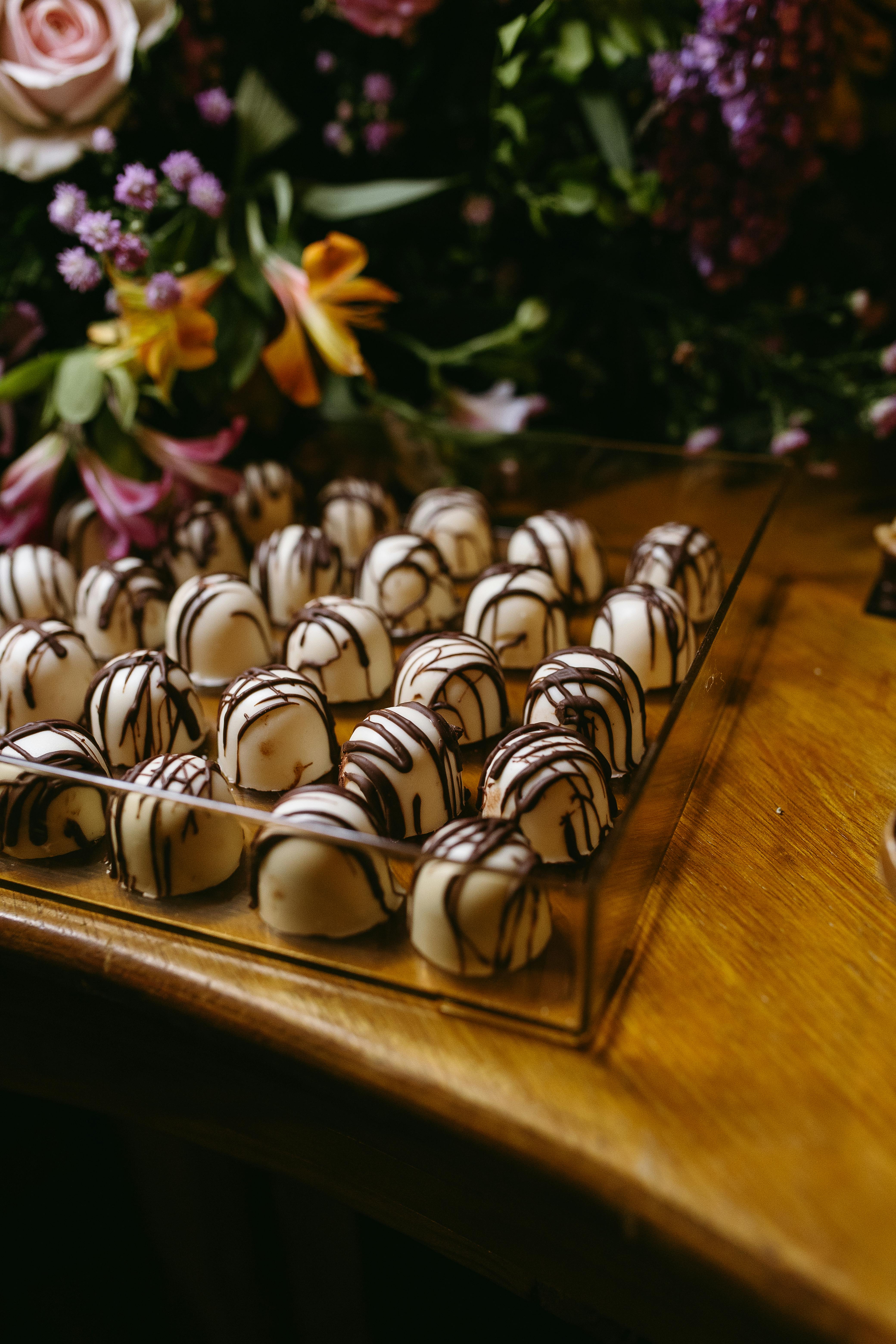 Elegant Chocolate Truffles with Floral Display · Free Stock Photo
