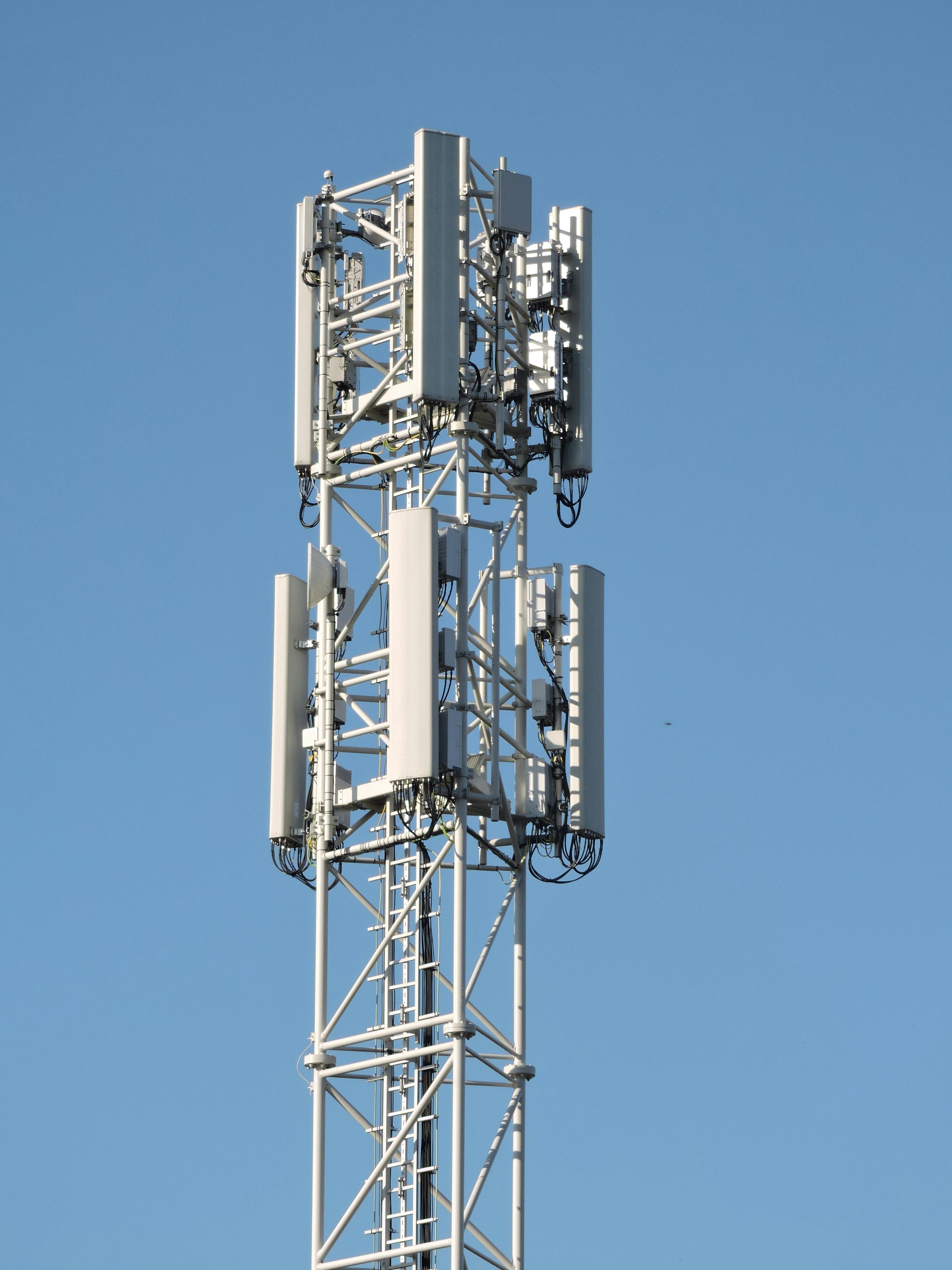 Modern Communication Tower Against Clear Blue Sky · Free Stock Photo