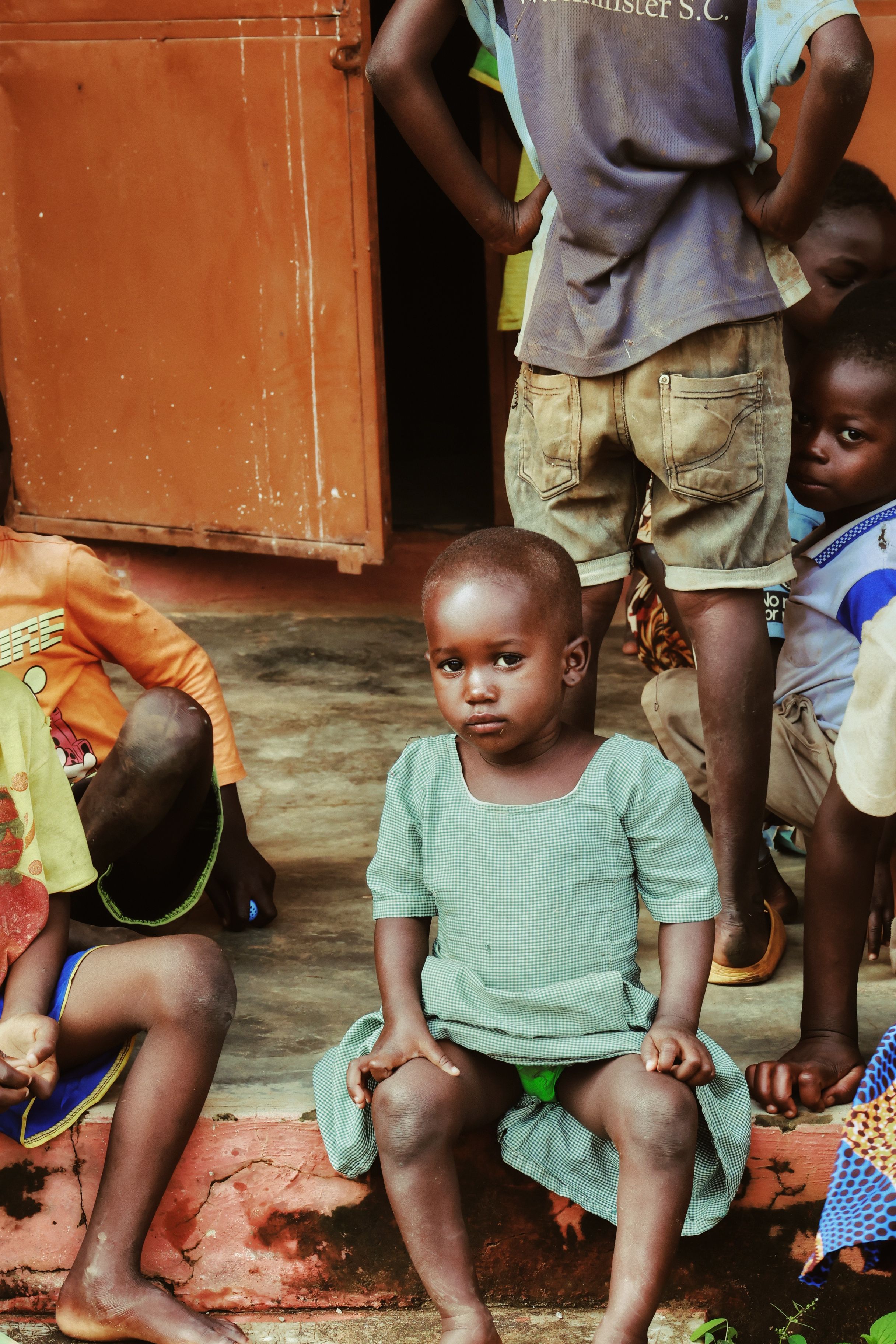 Children Sitting on Porch in Rural Setting · Free Stock Photo