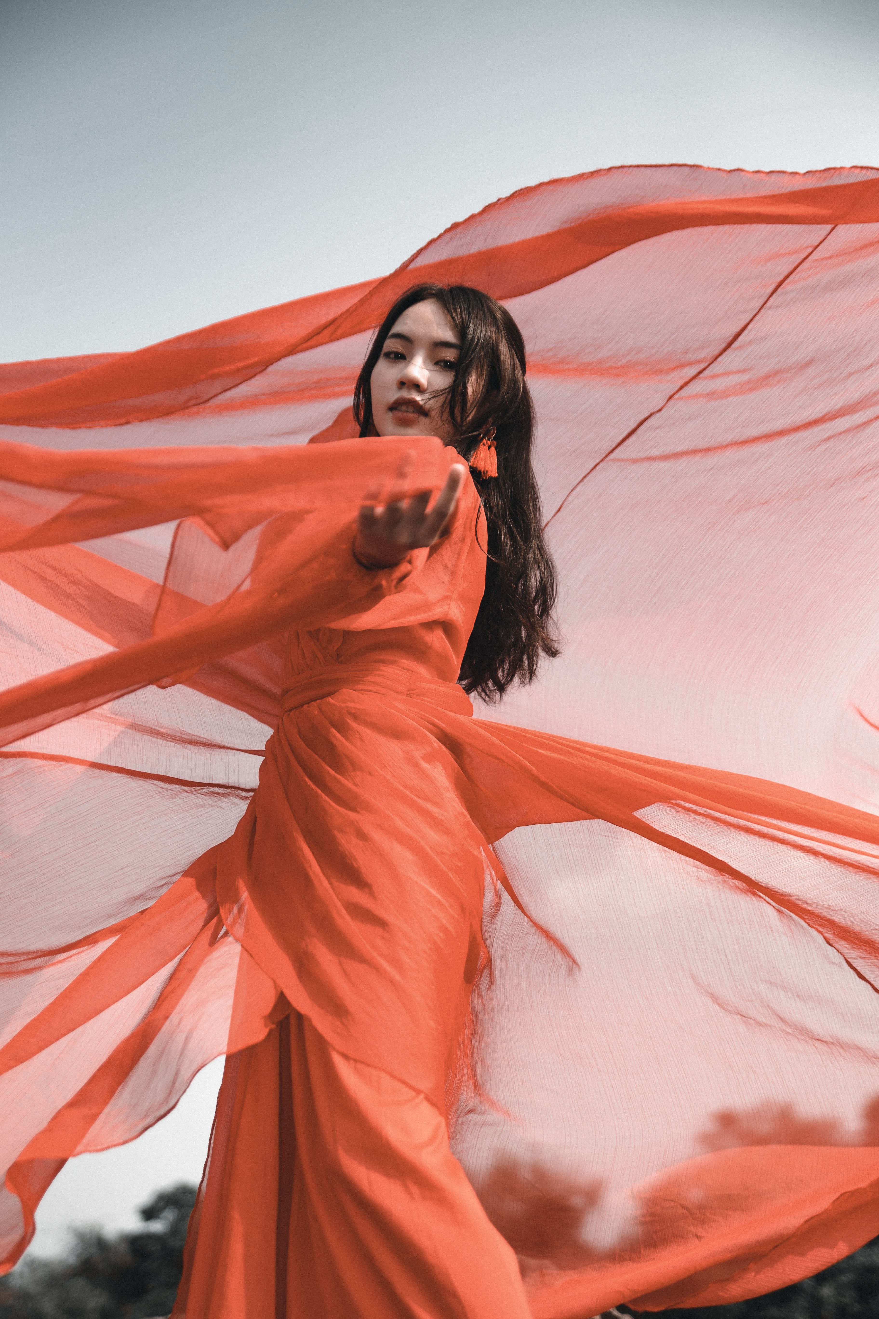 Elegant Woman in Flowing Red Dress Outdoors · Free Stock Photo