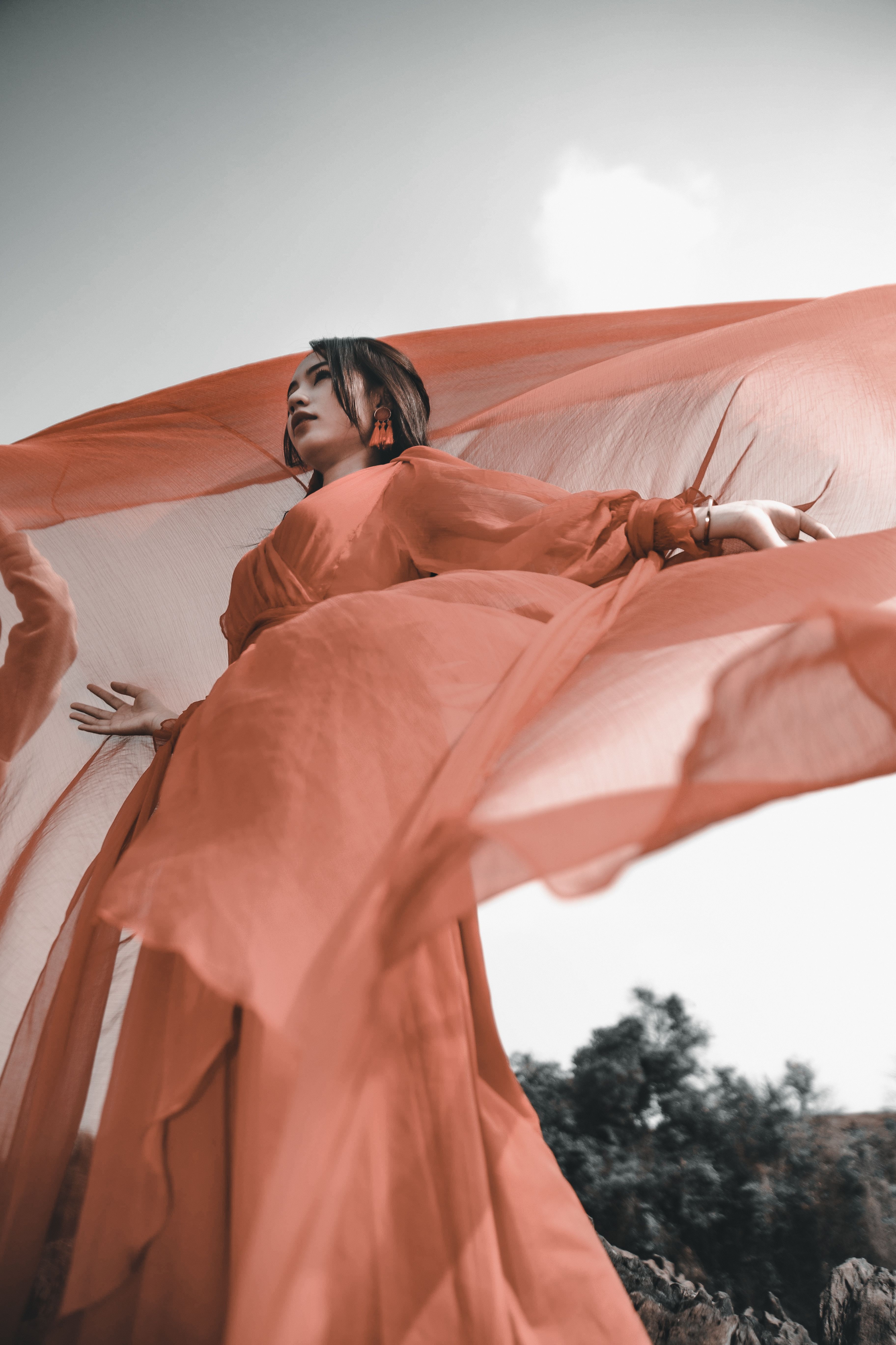 Elegant Woman in Flowing Red Dress Outdoors · Free Stock Photo
