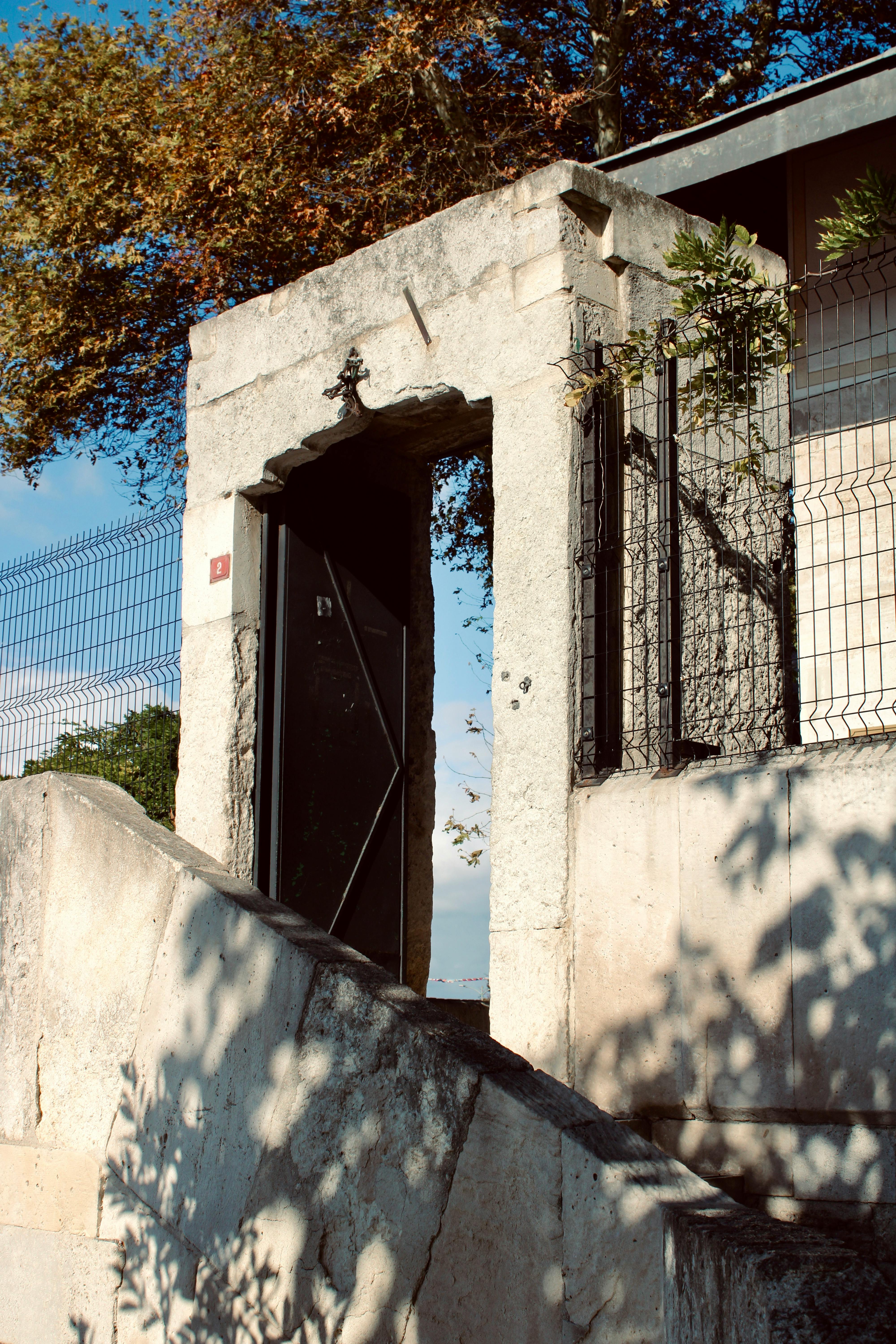 Old Stone Gate Entrance with Shadows and Sunlight · Free Stock Photo