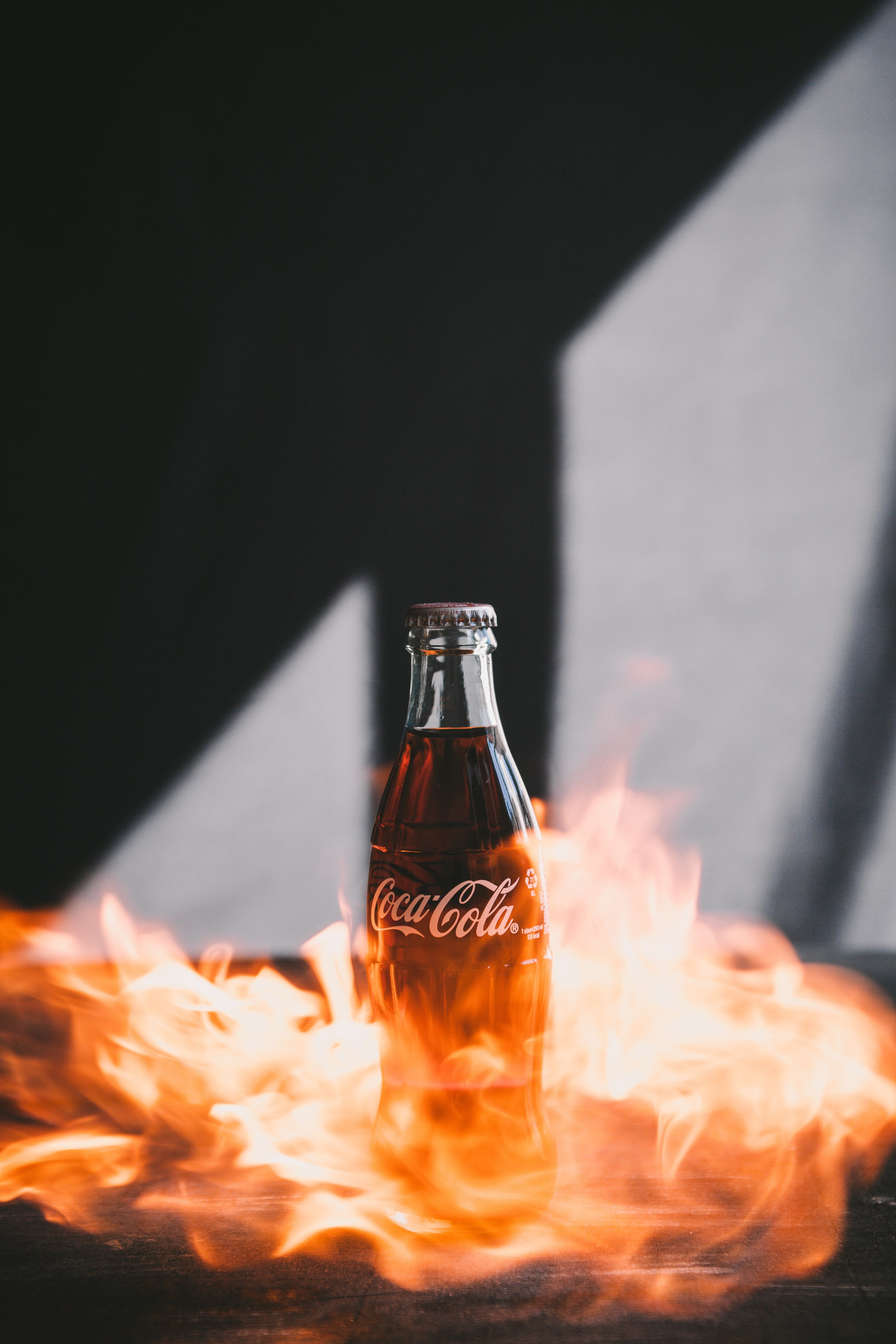 Fiery Coca-Cola Bottle on Black Background · Free Stock Photo
