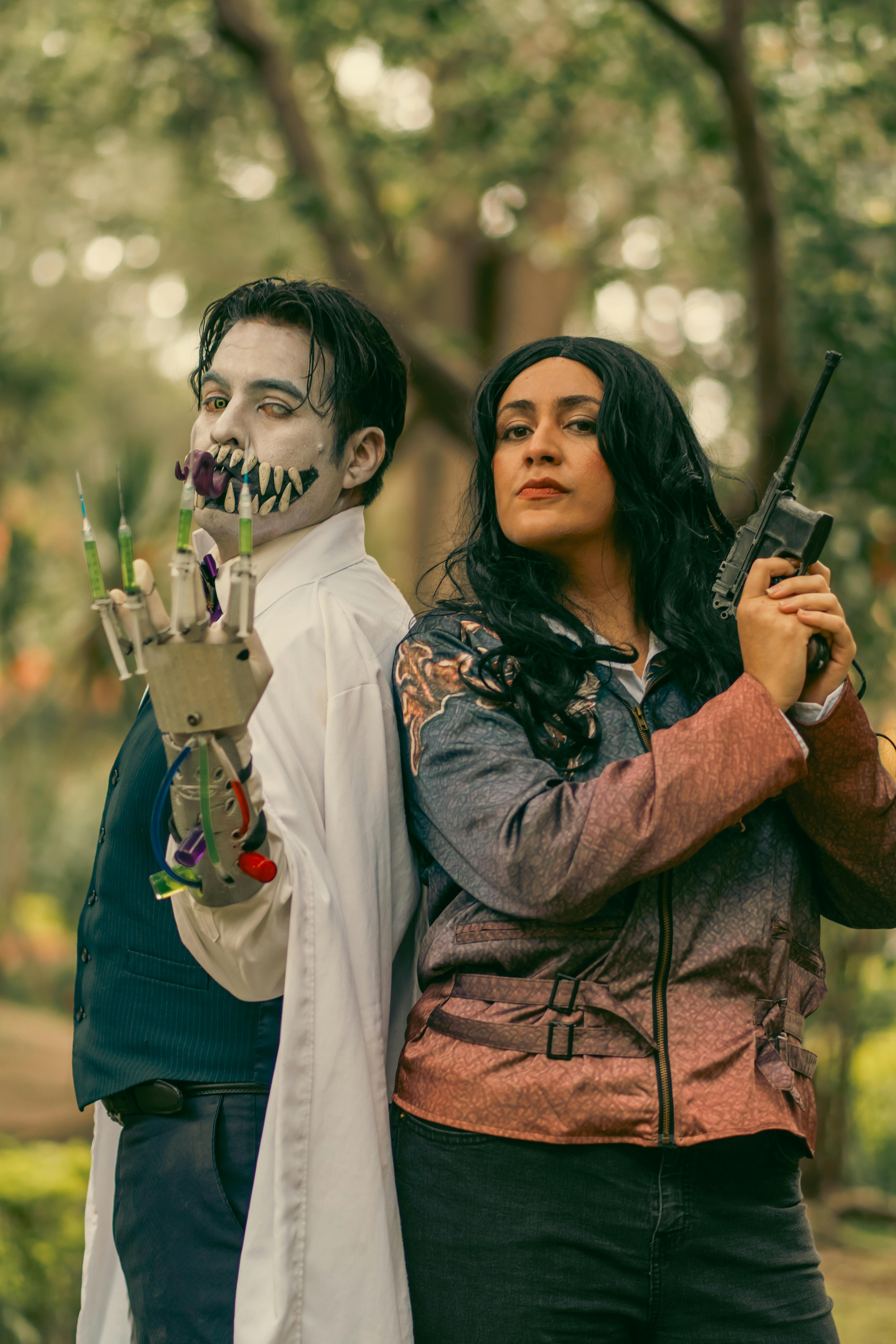 Cosplay Duo Posing with Props in Outdoor Setting · Free Stock Photo