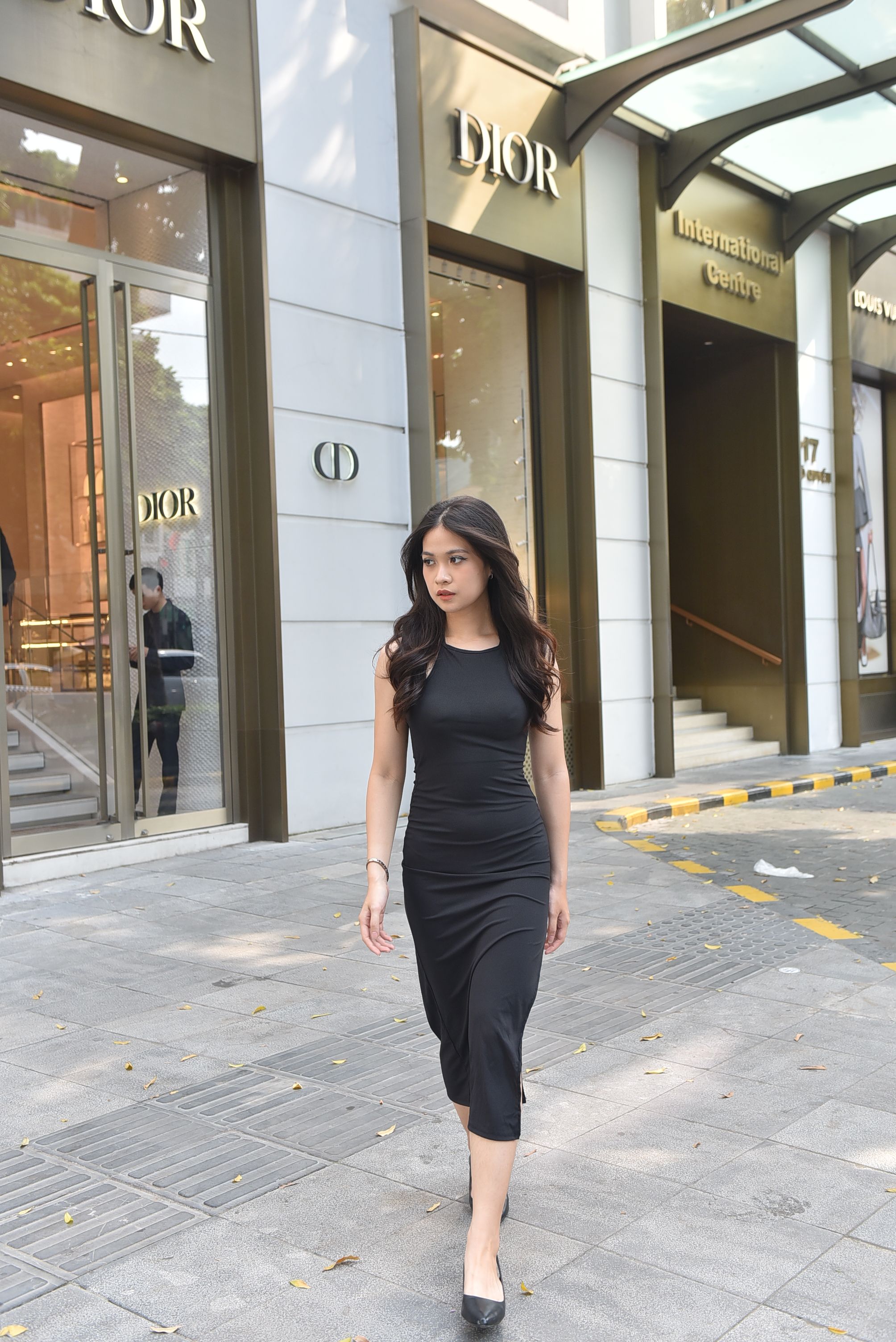Elegant Woman Walking by Dior Boutique · Free Stock Photo