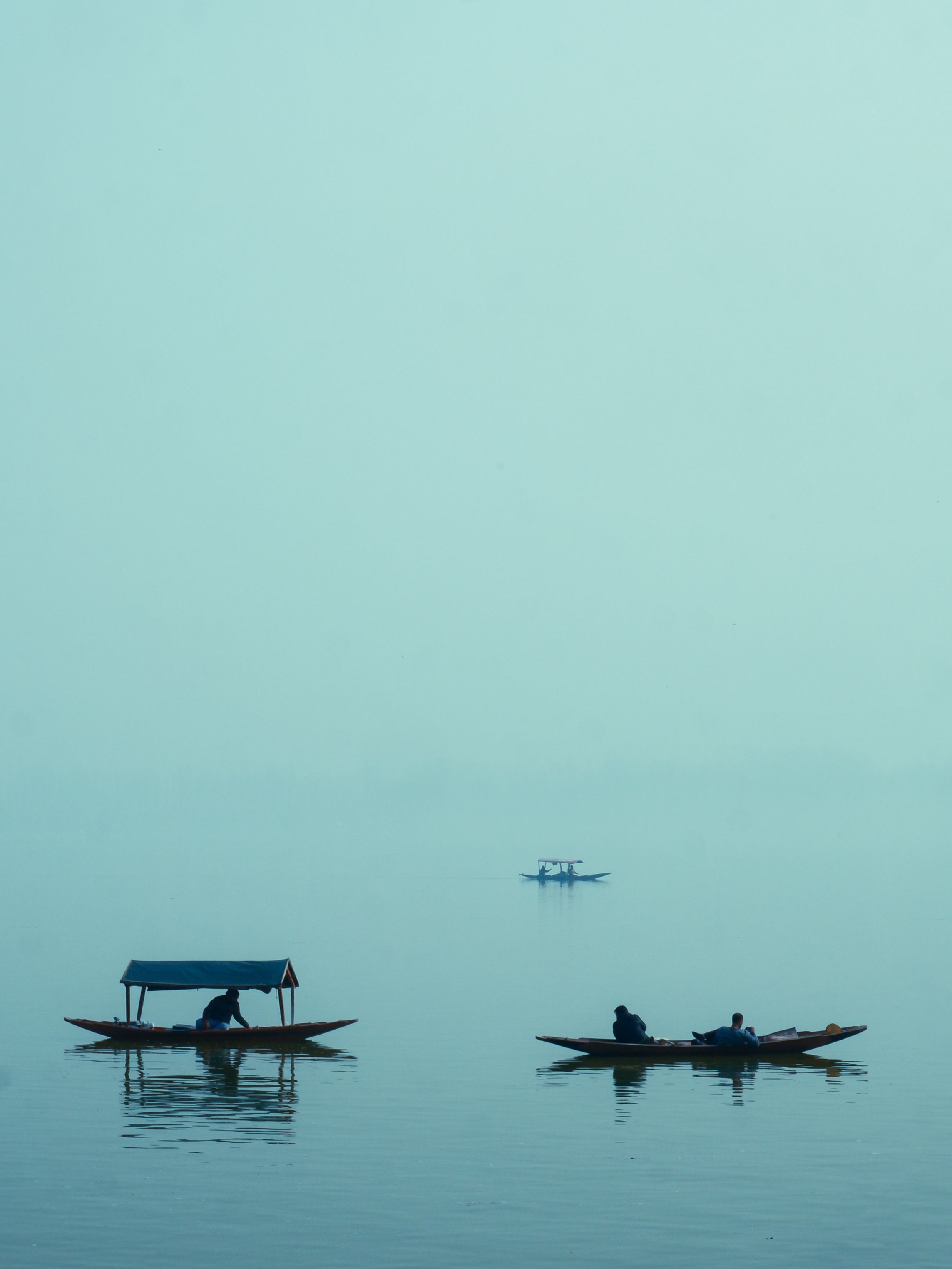 Serene Lake with Shikara Boats in Fog · Free Stock Photo