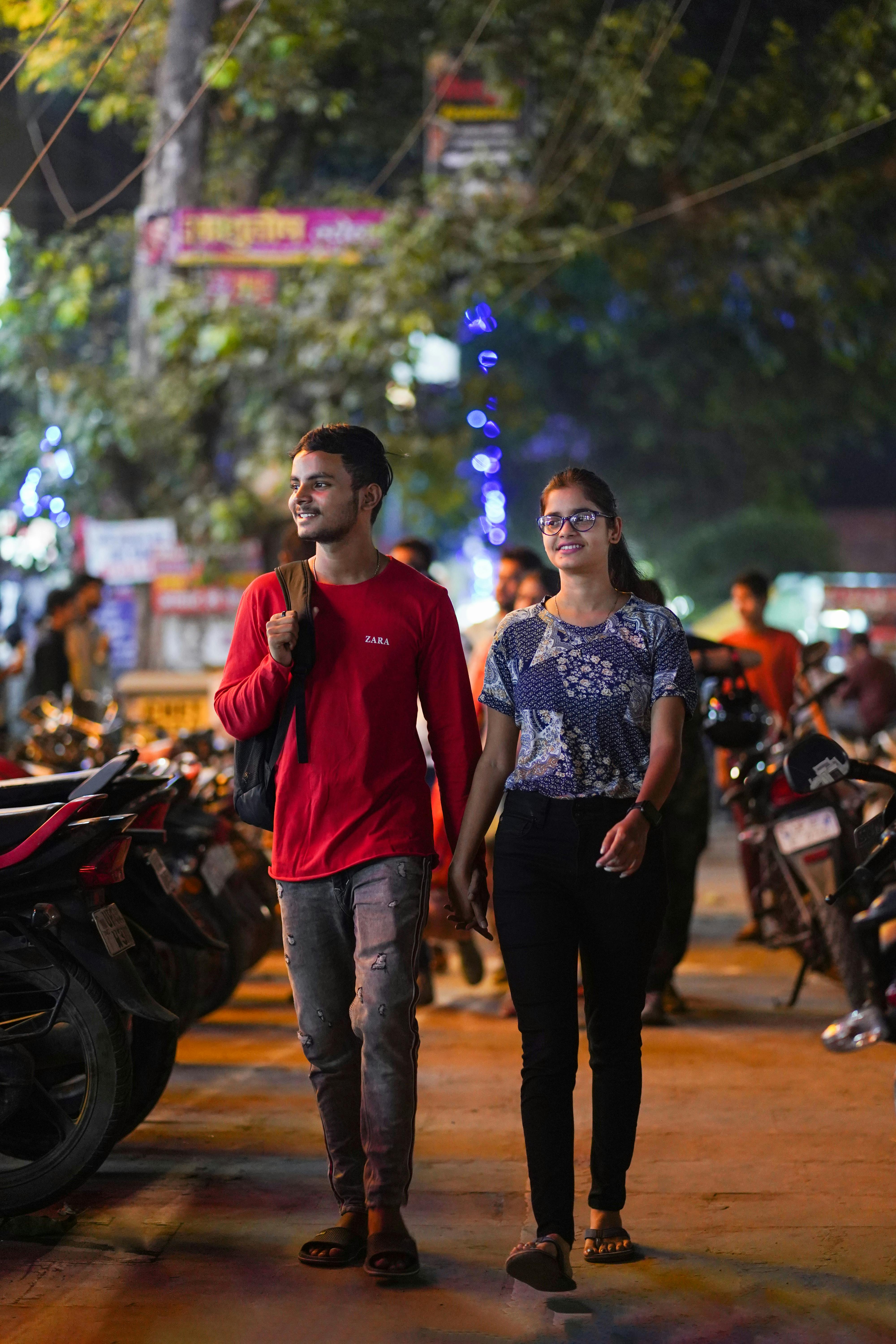 Young Couple Strolling Nighttime Varanasi Street · Free Stock Photo