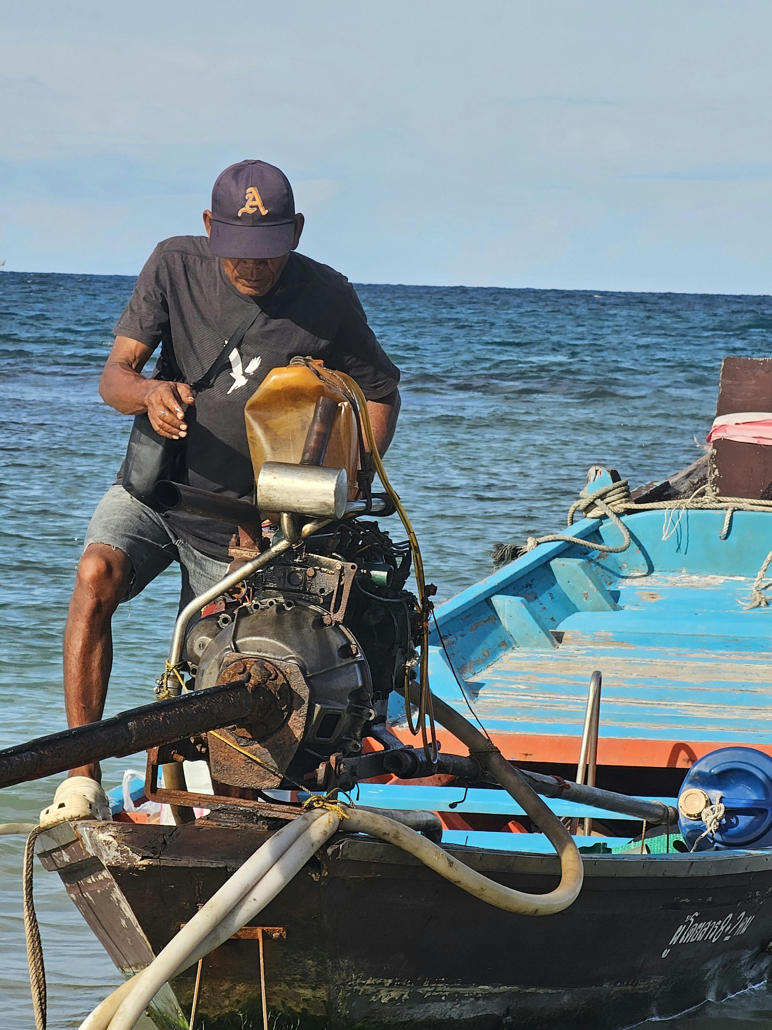 Fisherman Operating Motorized Boat at Sea · Free Stock Photo