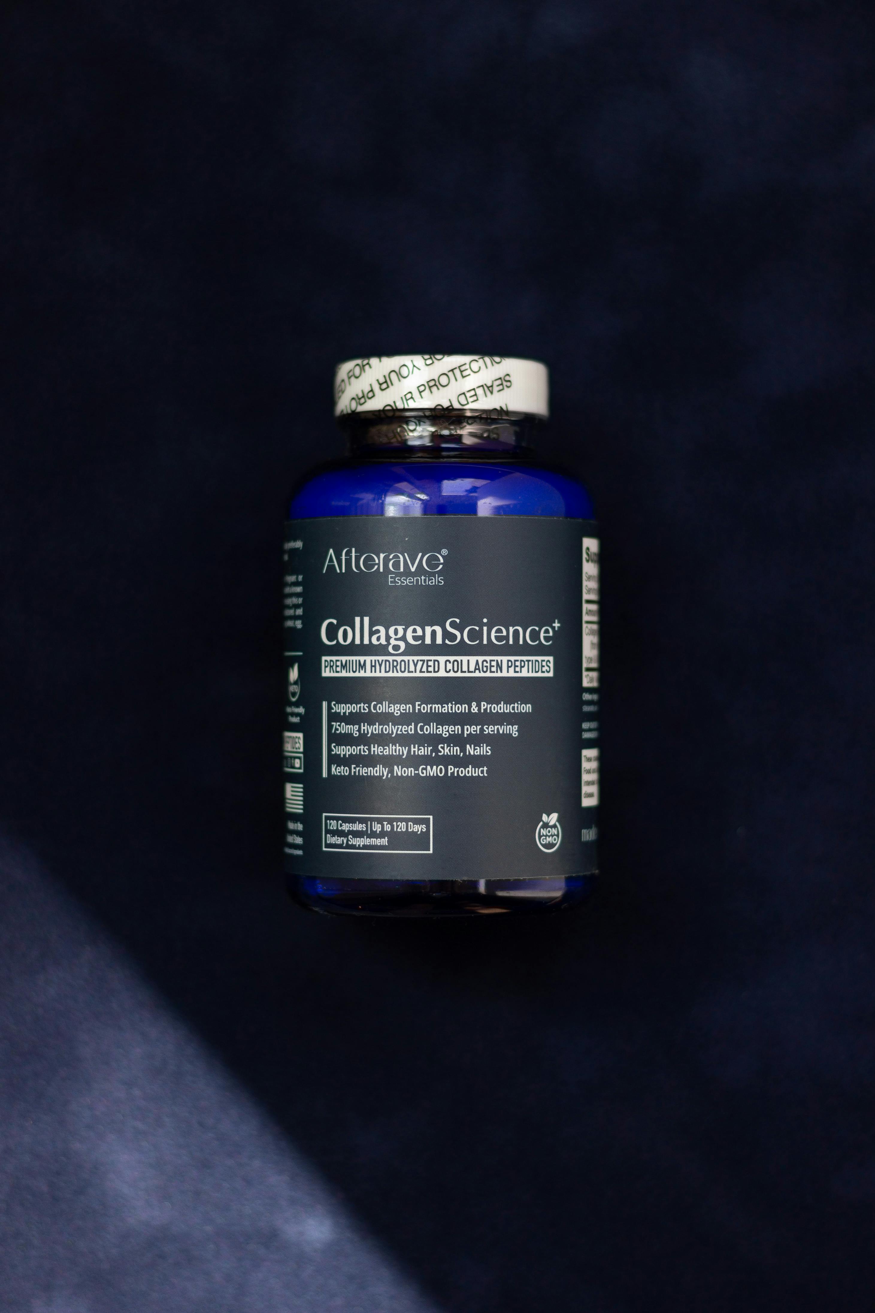 CollagenScience Supplement Bottle on Dark Background · Free Stock Photo