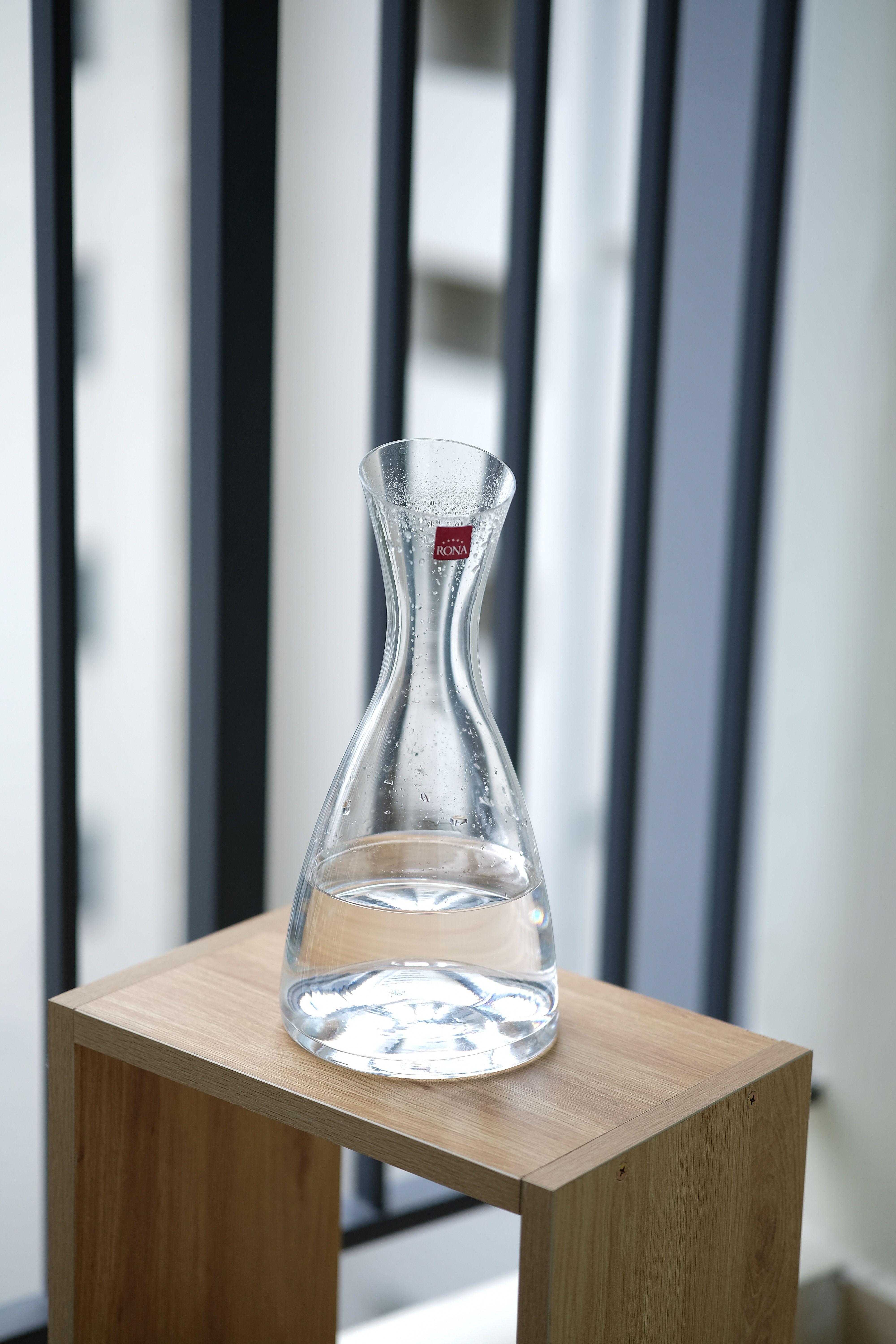 Elegant Glass Carafe of Water on Wooden Stand · Free Stock Photo