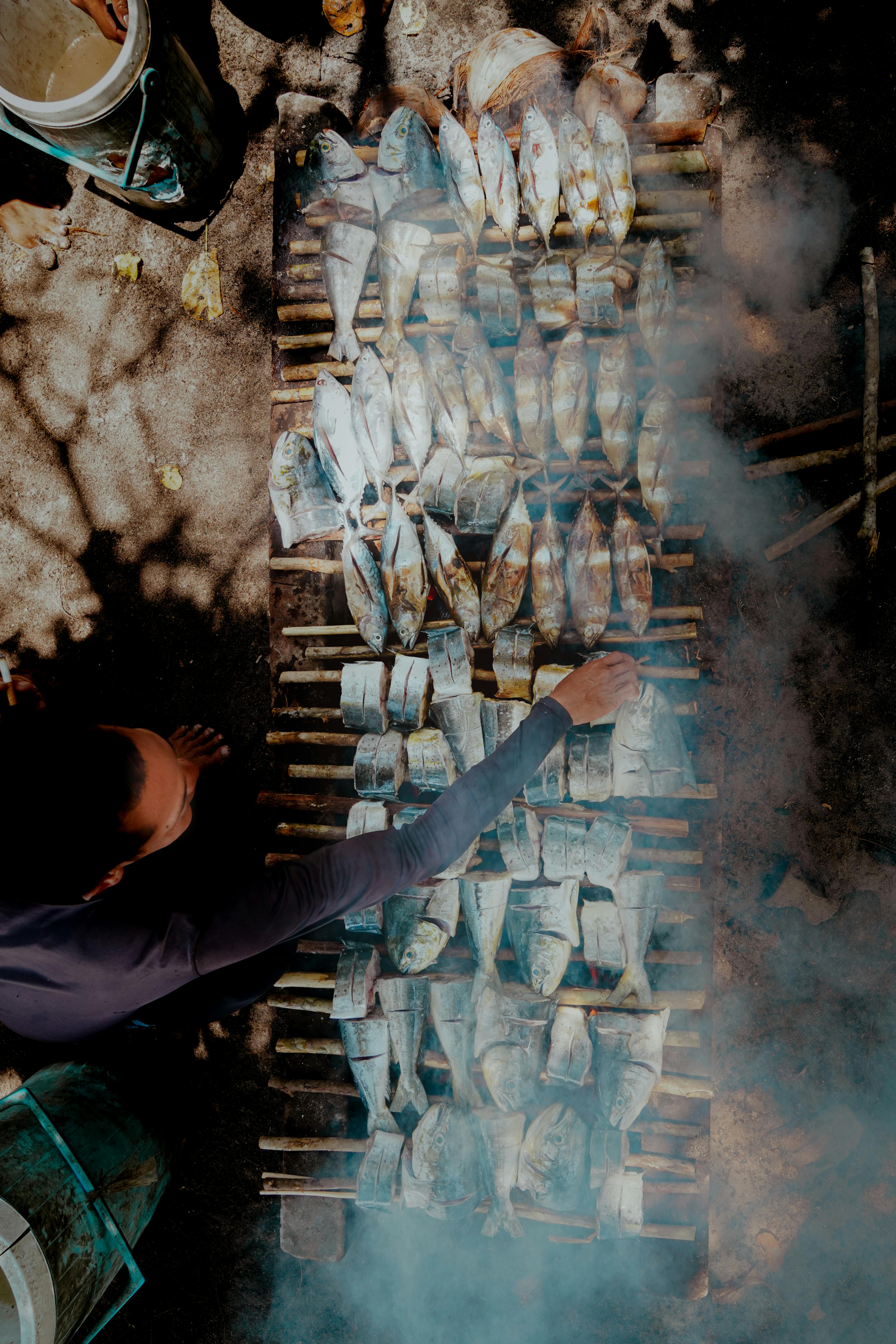 Traditional Fish Smoking in Outdoor Setting · Free Stock Photo