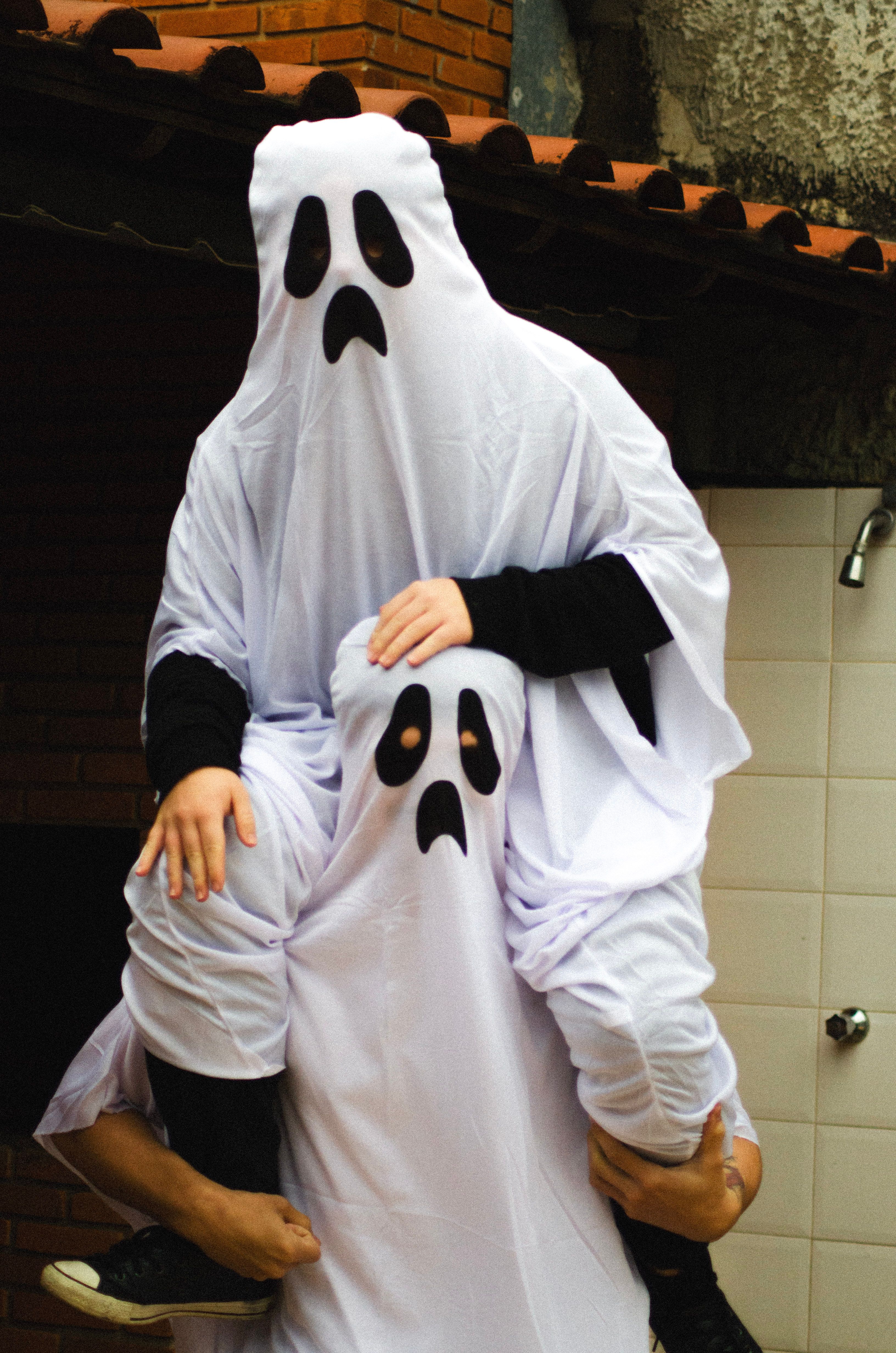 Halloween Ghost Costumes in Outdoor Setting · Free Stock Photo