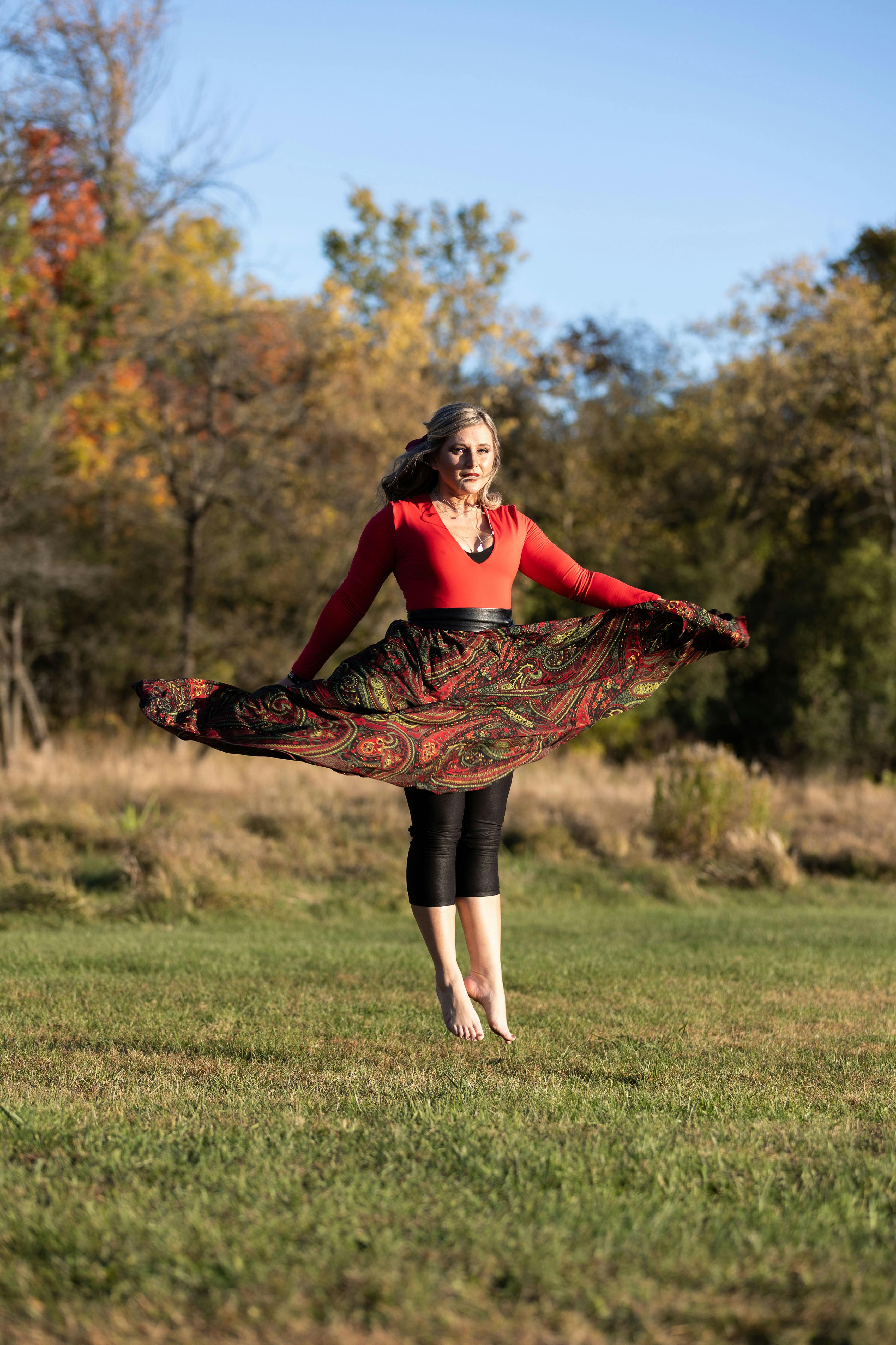 Woman Twirling in Colorful Skirt During Fall in Chicago · Free Stock Photo