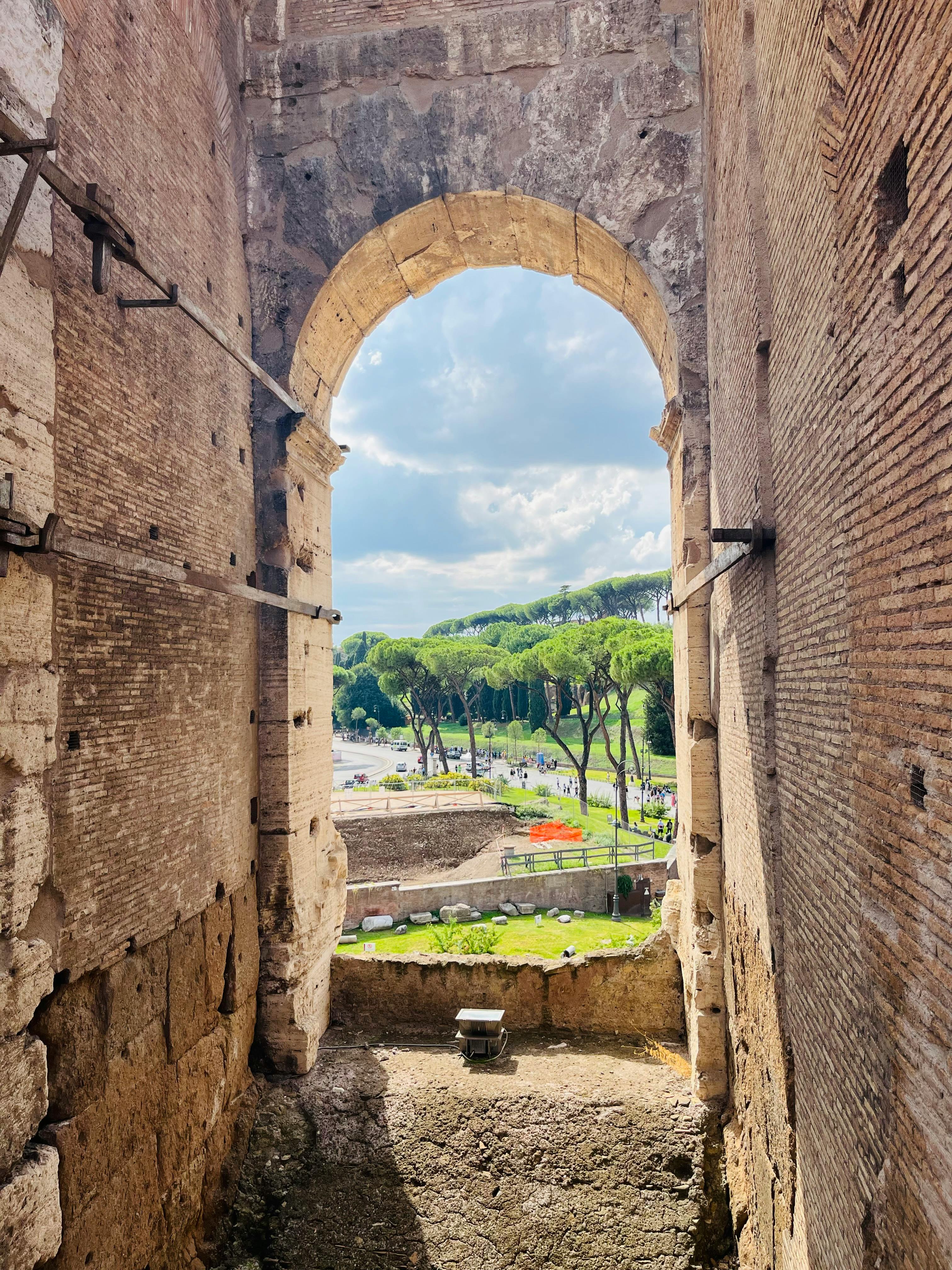Scenic View Through Ancient Colosseum Archway · Free Stock Photo