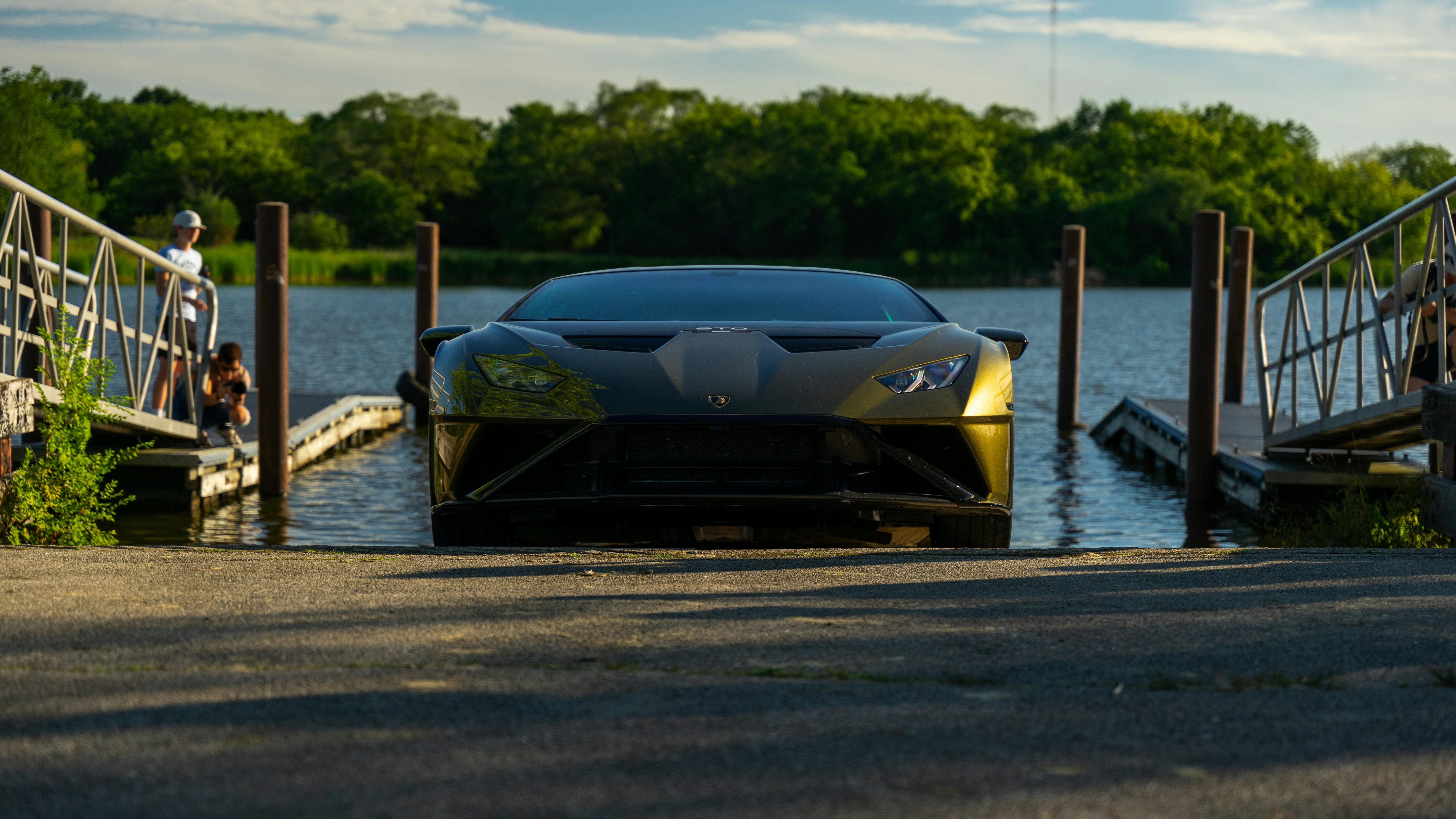 Luxury Sports Car at Scenic Lakeside Dock · Free Stock Photo