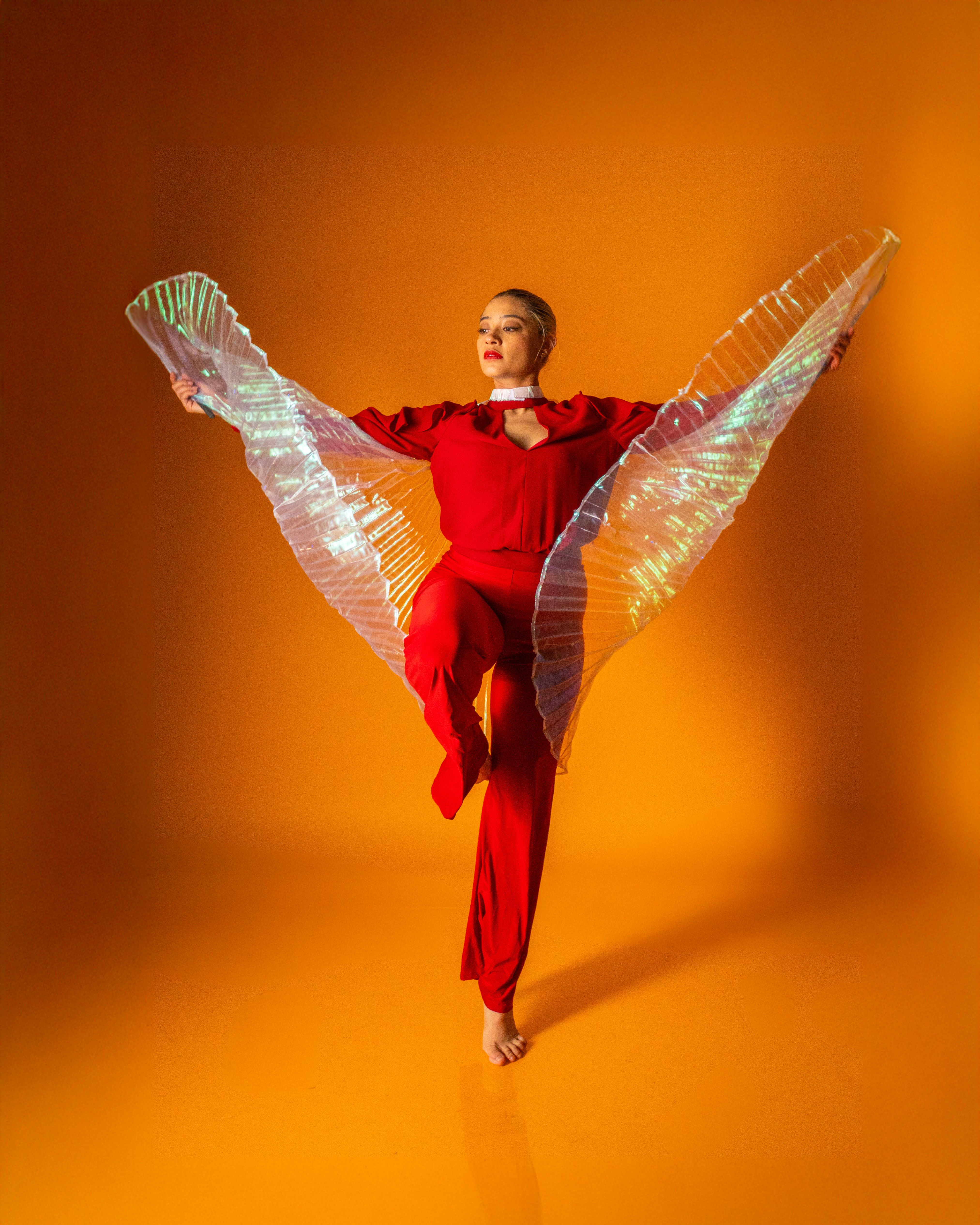 Dynamic Contemporary Dancer on Orange Background · Free Stock Photo