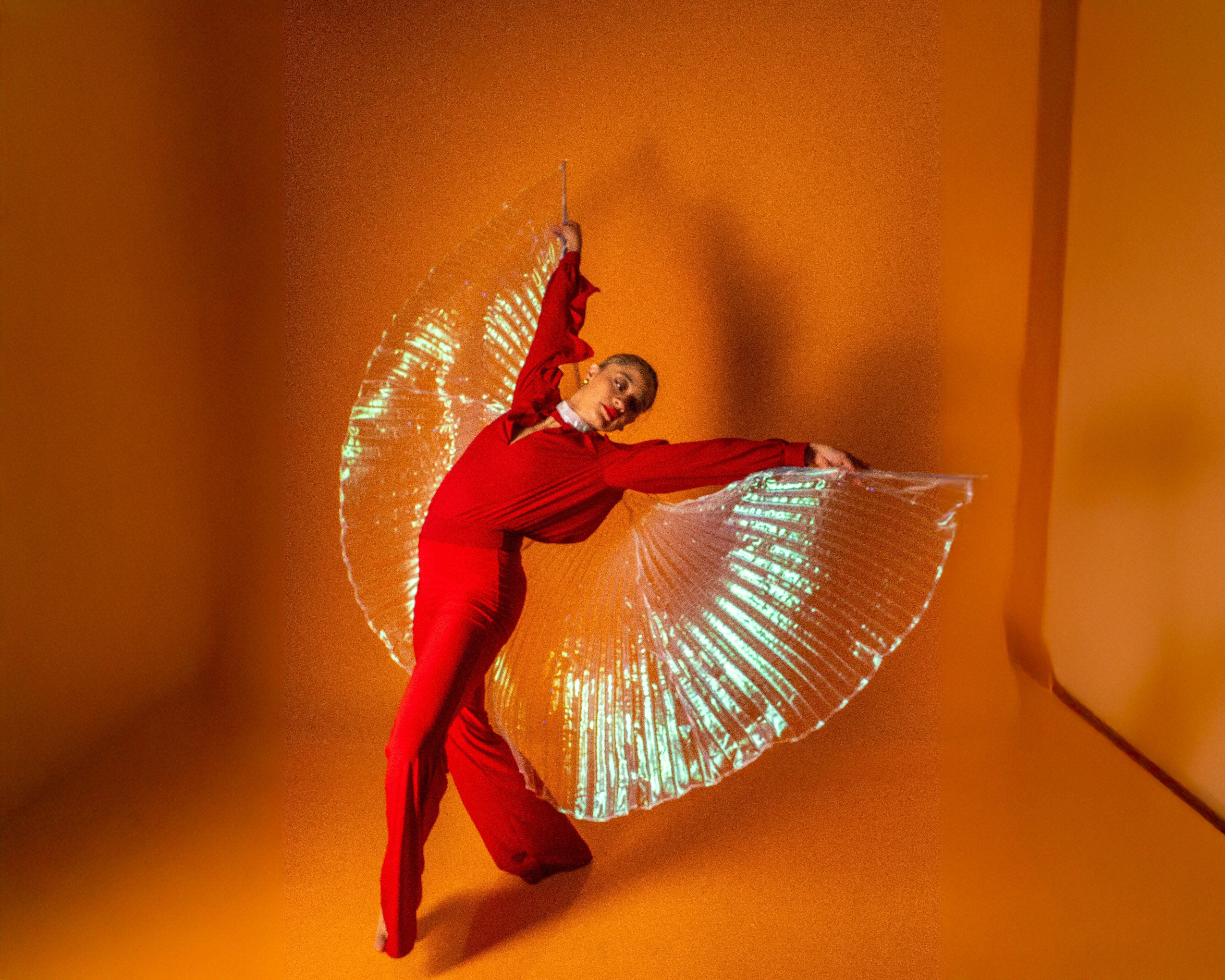 Elegant Latina Dancer in Red with Angel Wings · Free Stock Photo