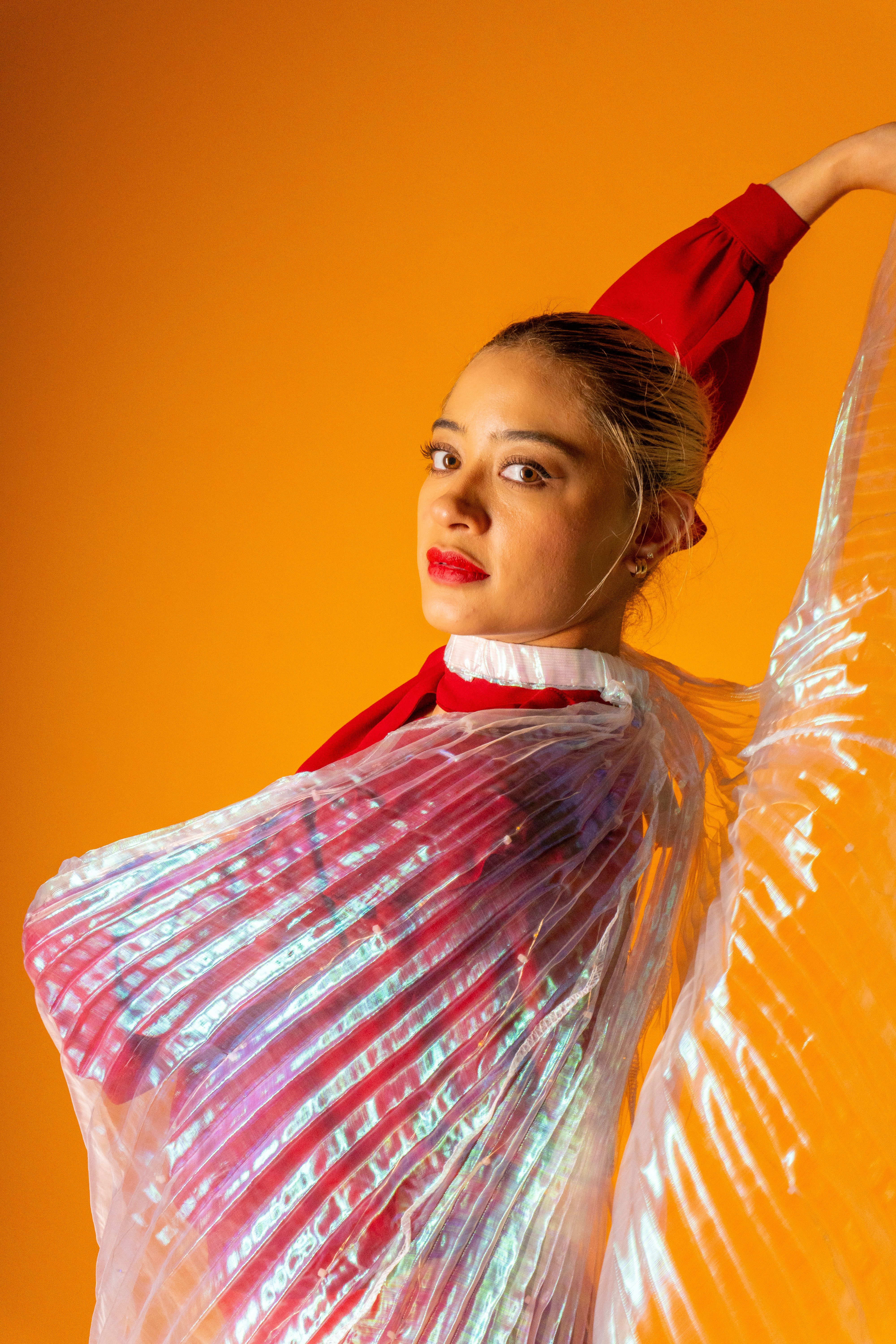 Expressive Dancer in Vibrant Orange Background · Free Stock Photo