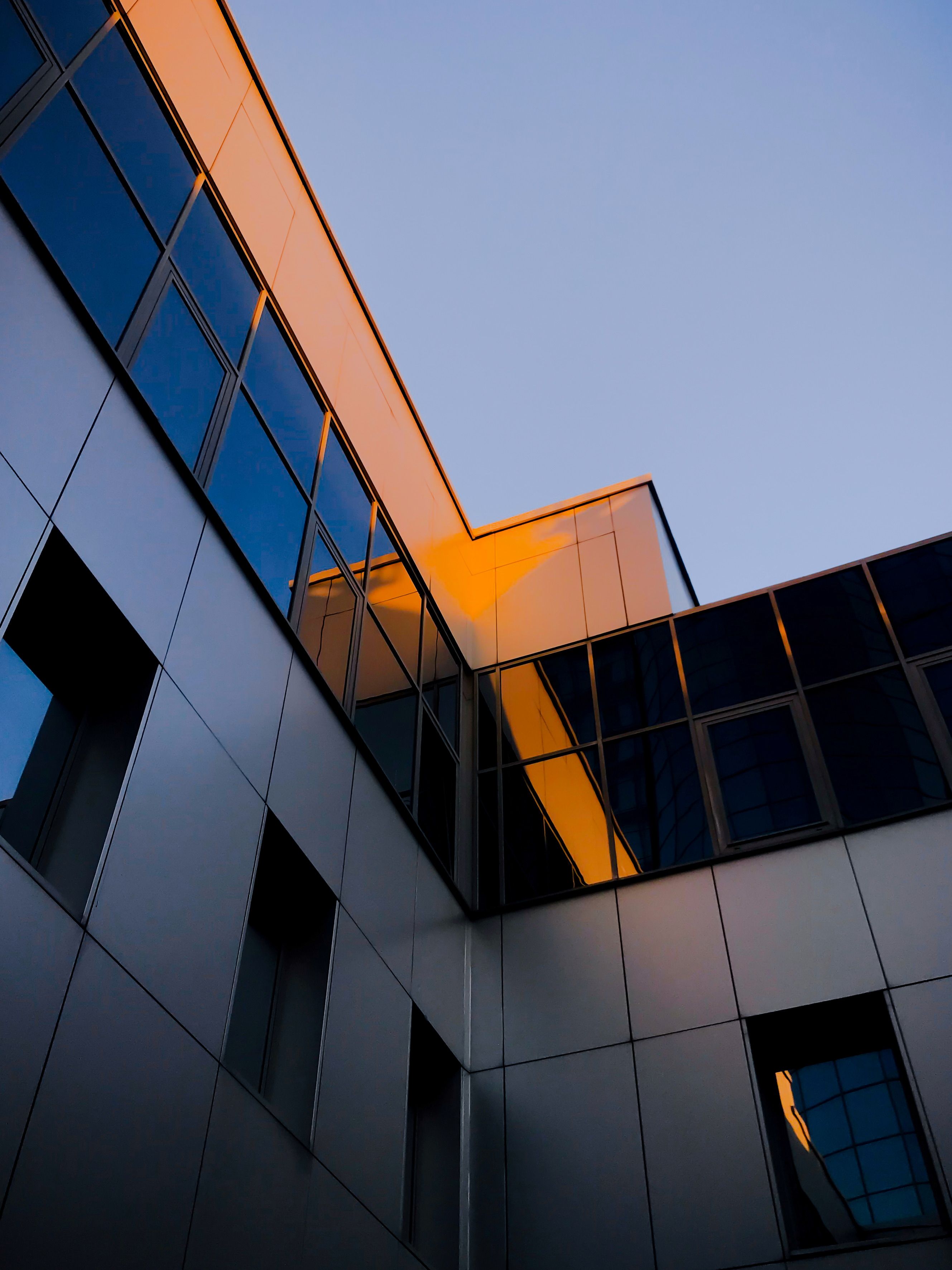 Modern Architecture in Reflective Evening Light · Free Stock Photo