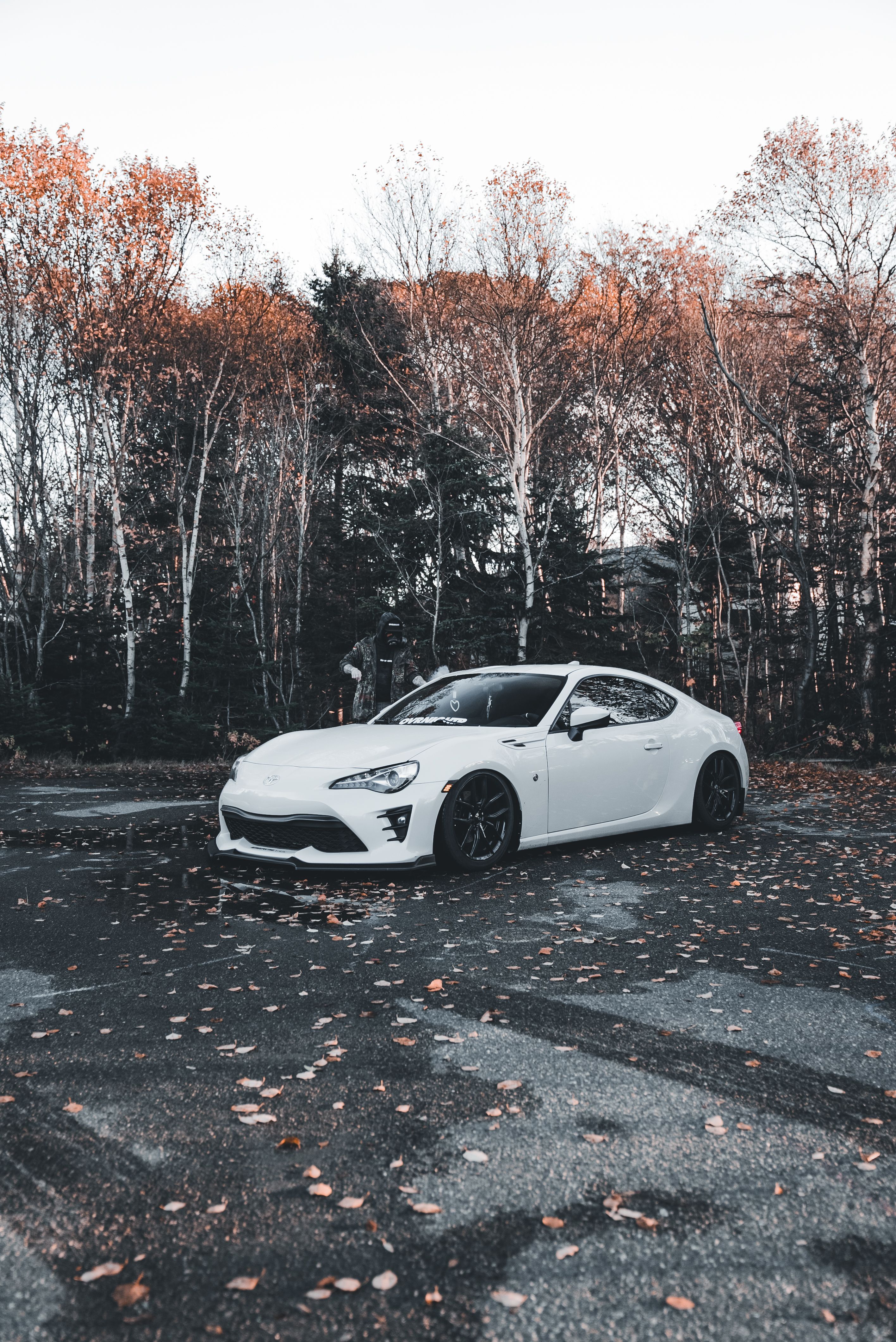 Sleek White Car in Scenic Autumn Landscape · Free Stock Photo