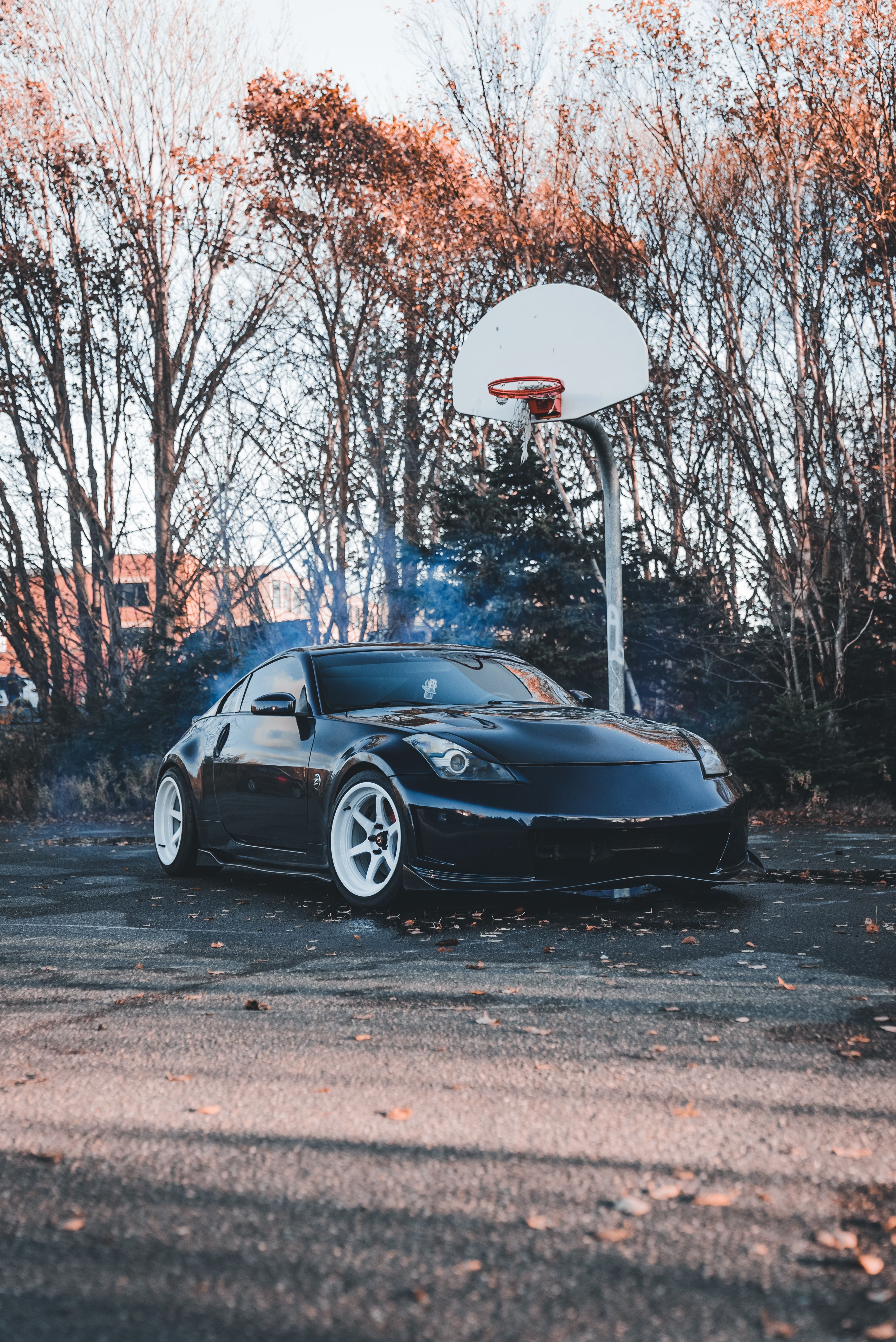Sporty Car Under Basketball Hoop in Autumn · Free Stock Photo