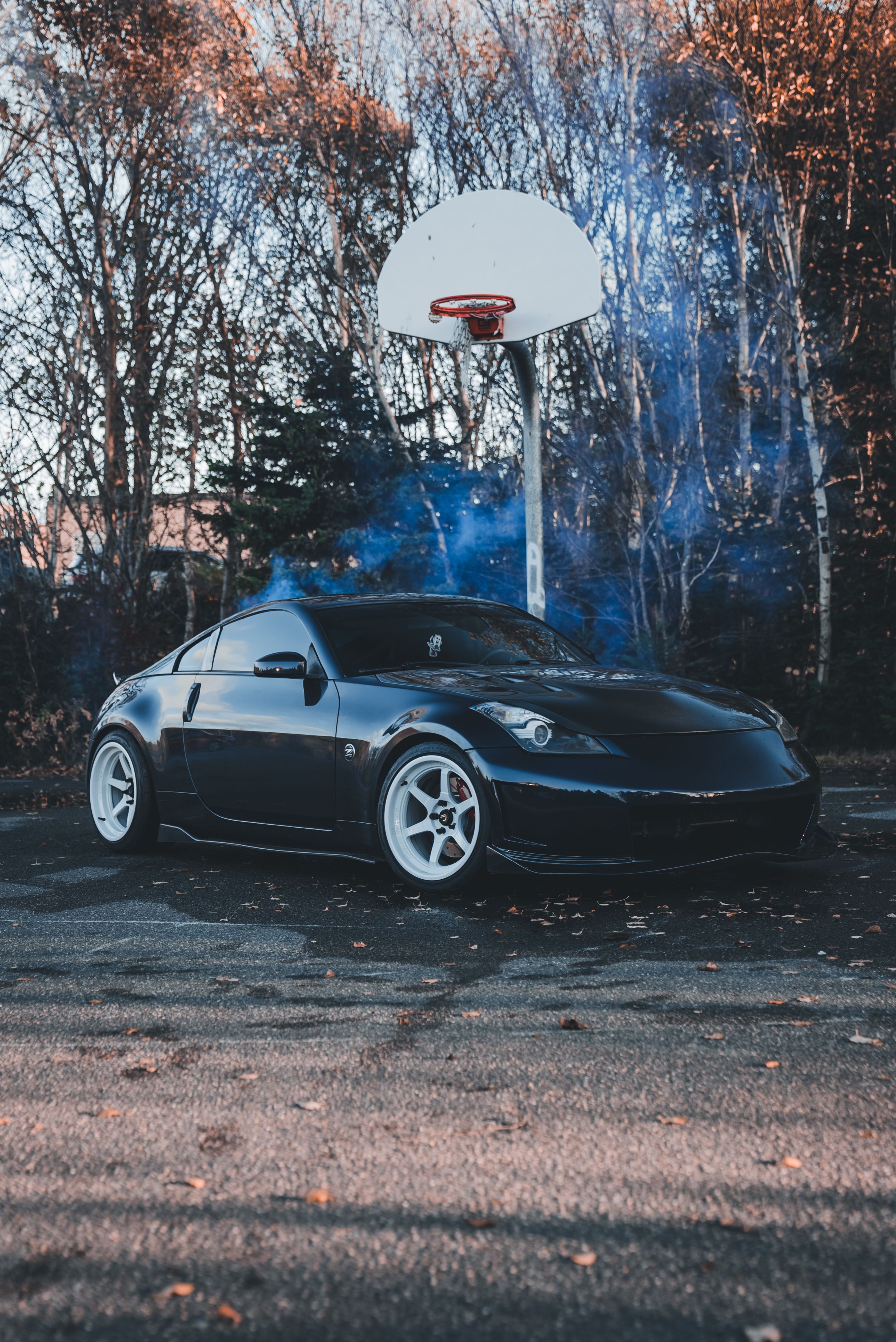 Sports Car Under Basketball Hoop in Autumn Setting · Free Stock Photo