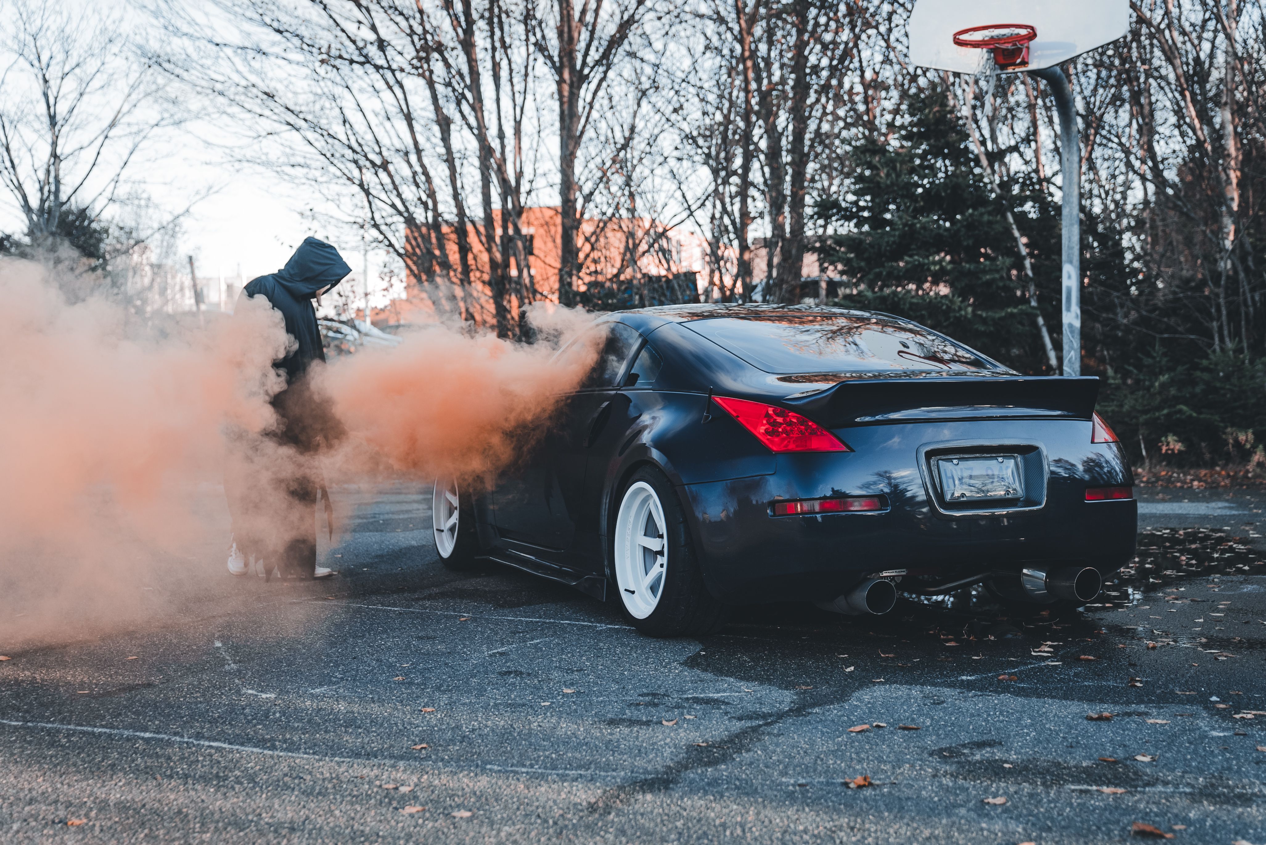 Dynamic Car Burnout with Orange Smoke Outdoors · Free Stock Photo
