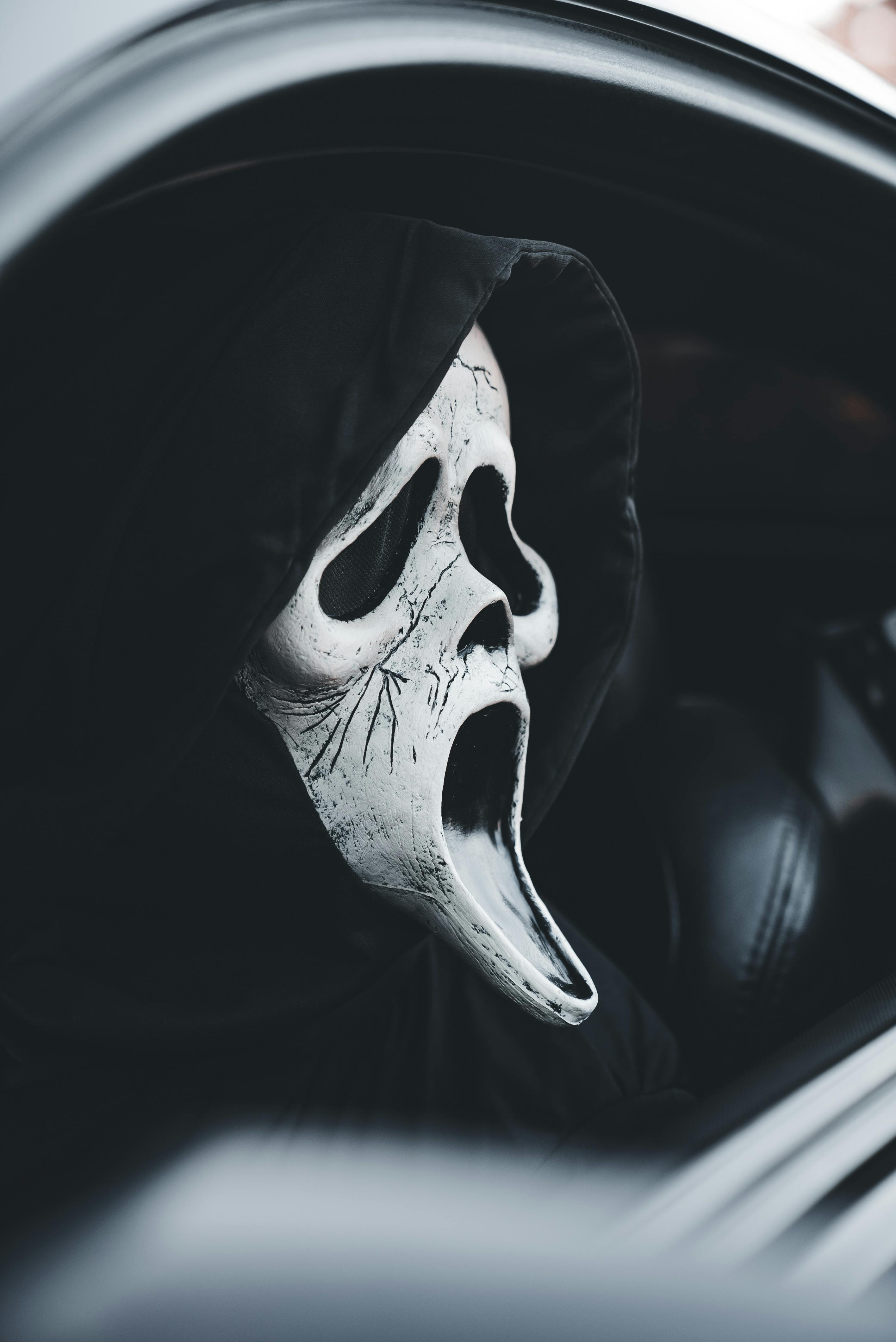 Person Wearing Scary Scream Mask in Car Window · Free Stock Photo