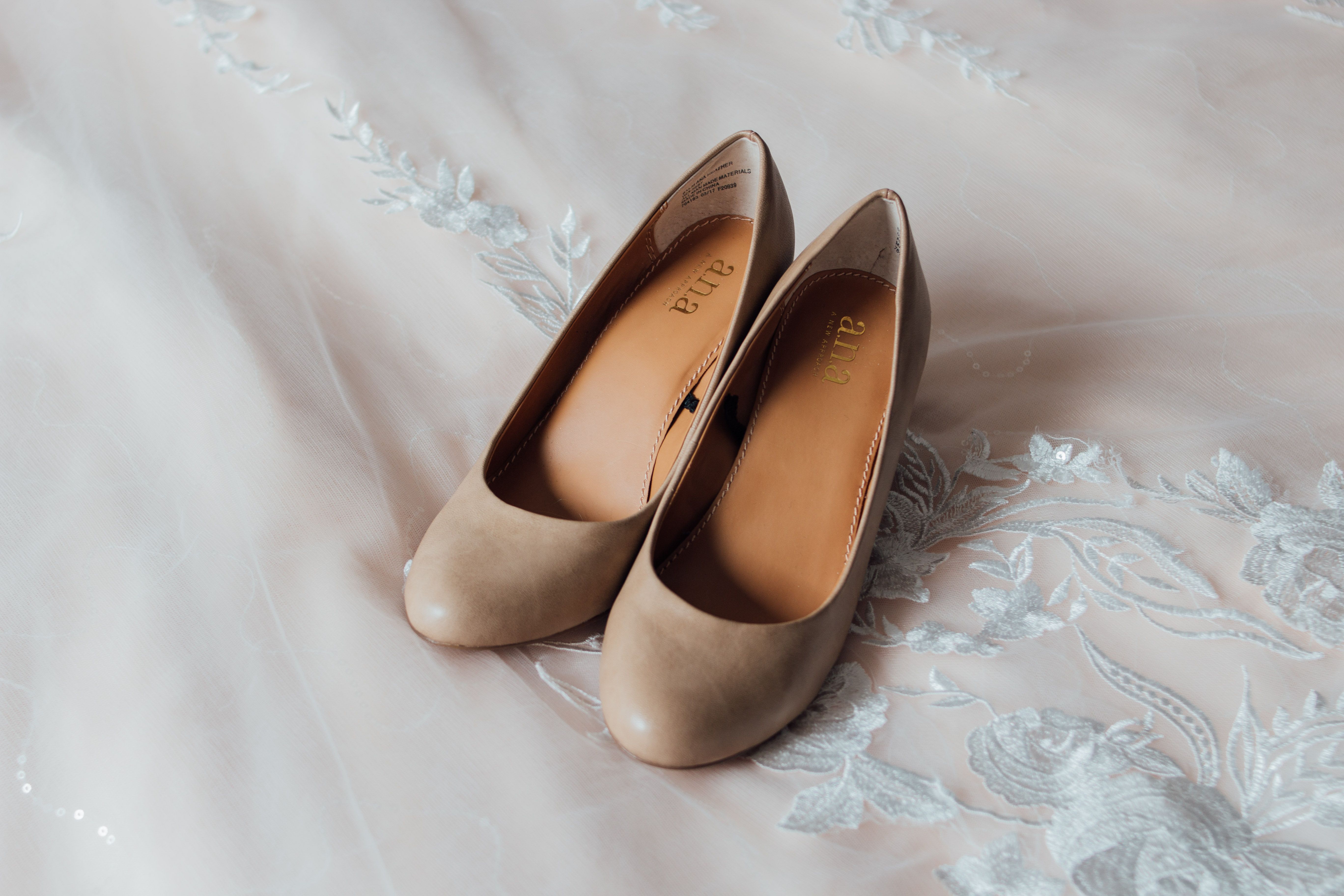 Elegant Beige Women's Shoes on Embroidered Fabric · Free Stock Photo
