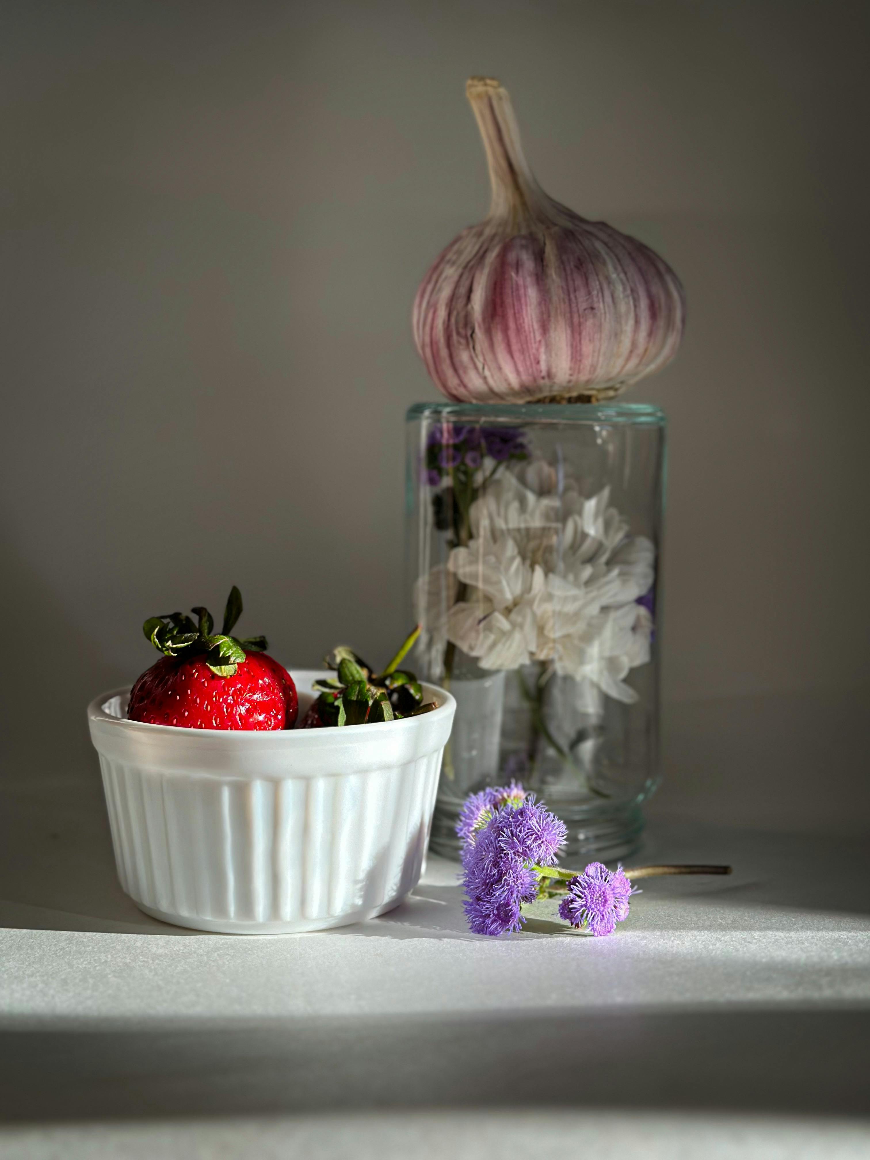 Still Life with Strawberries, Garlic, and Flowers · Free Stock Photo