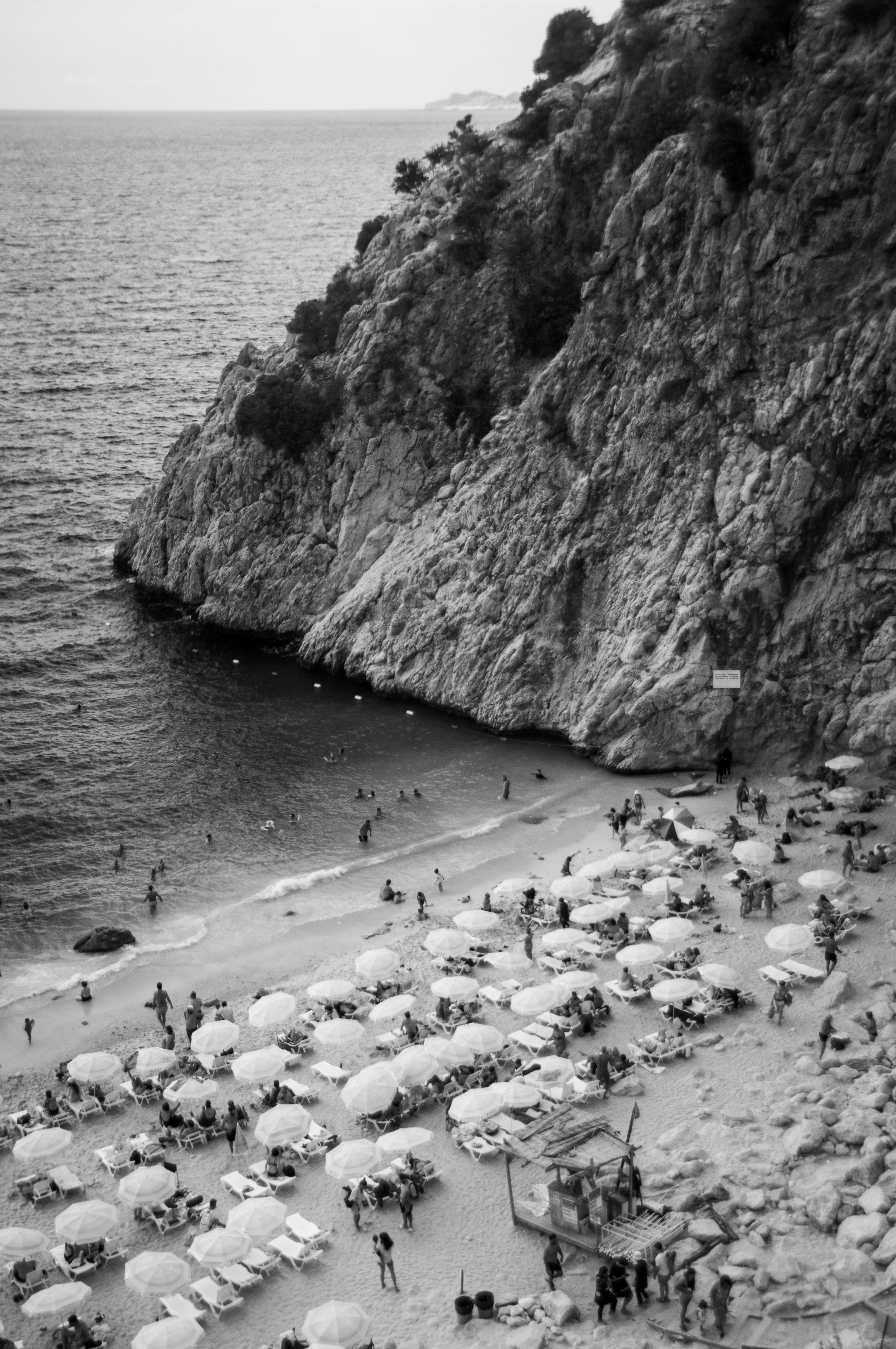 Scenic Beach View with Cliffs and Umbrellas · Free Stock Photo