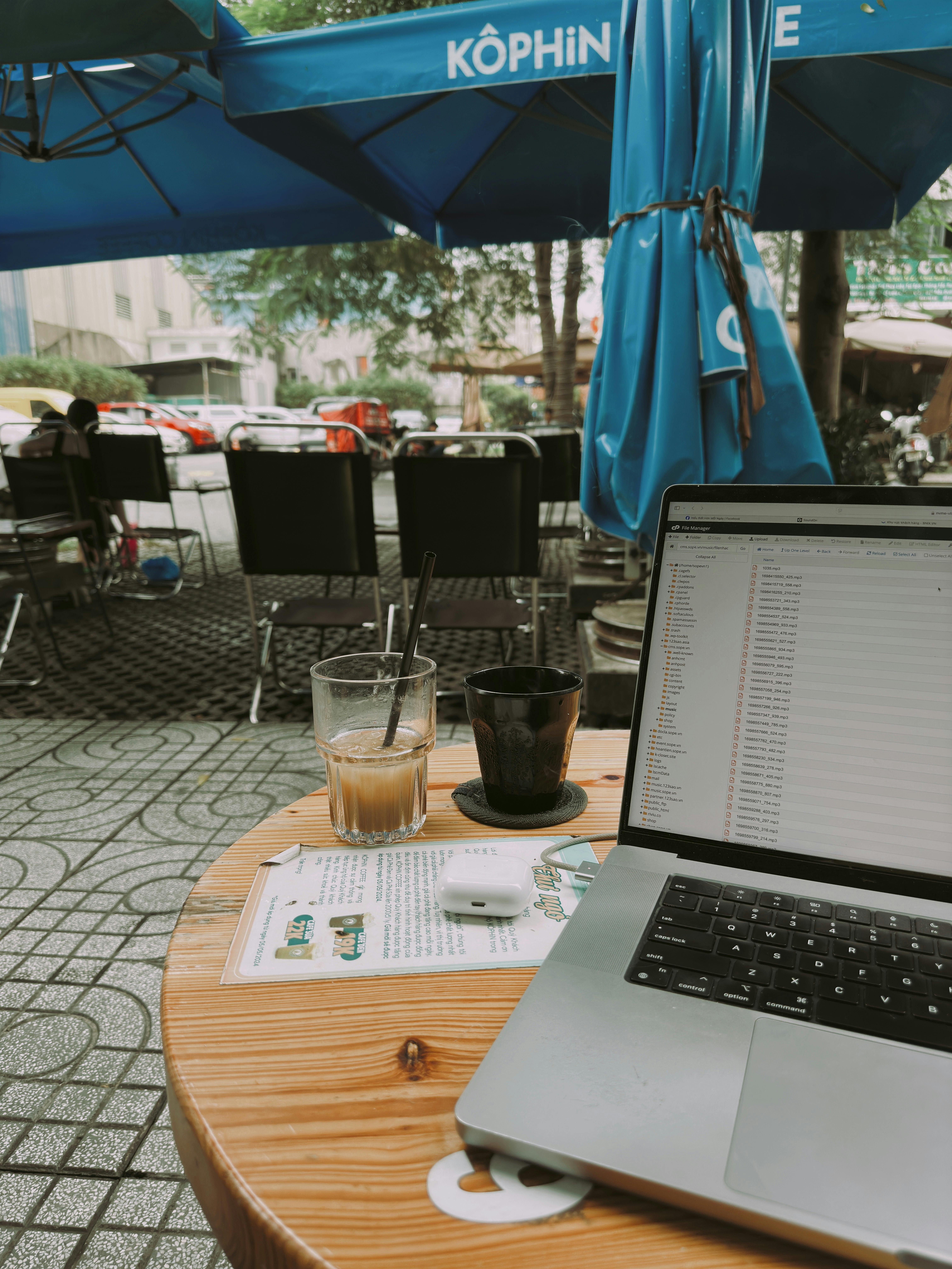 Laptop and Coffee at Outdoor Cafe Workspace · Free Stock Photo