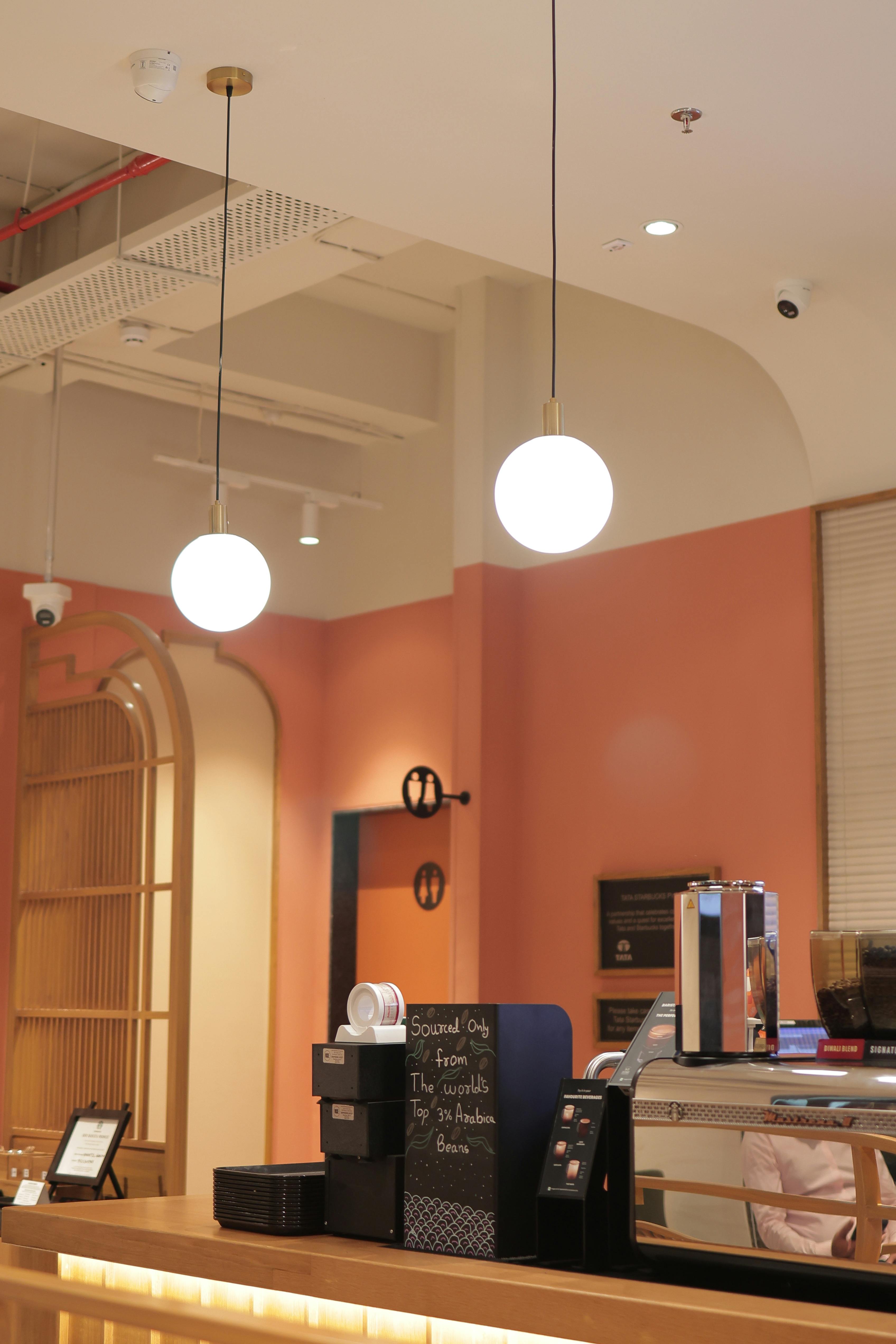 Modern Coffee Shop Interior with Warm Lighting · Free Stock Photo