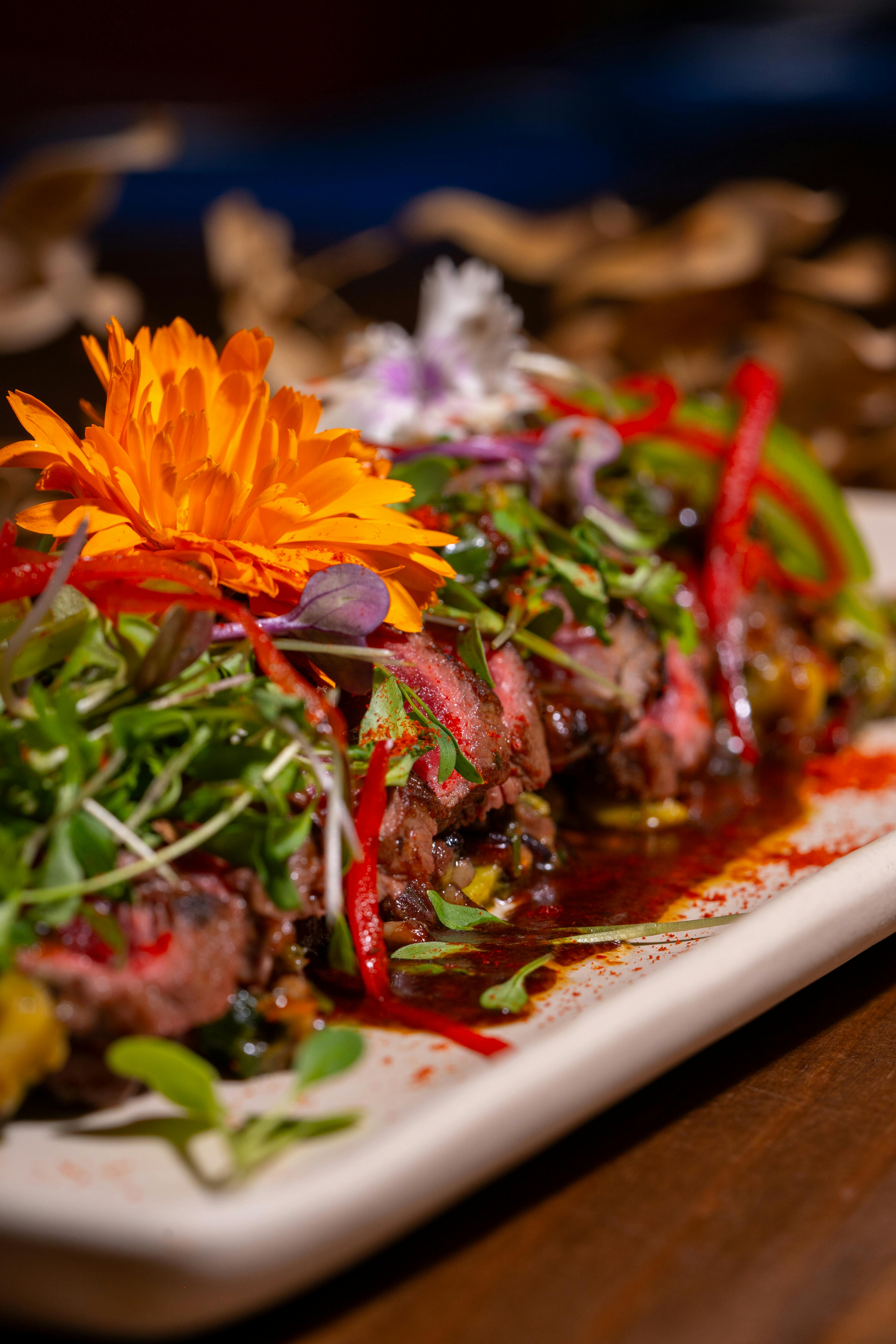 Gourmet Beef Steak with Edible Flowers and Microgreens · Free Stock Photo