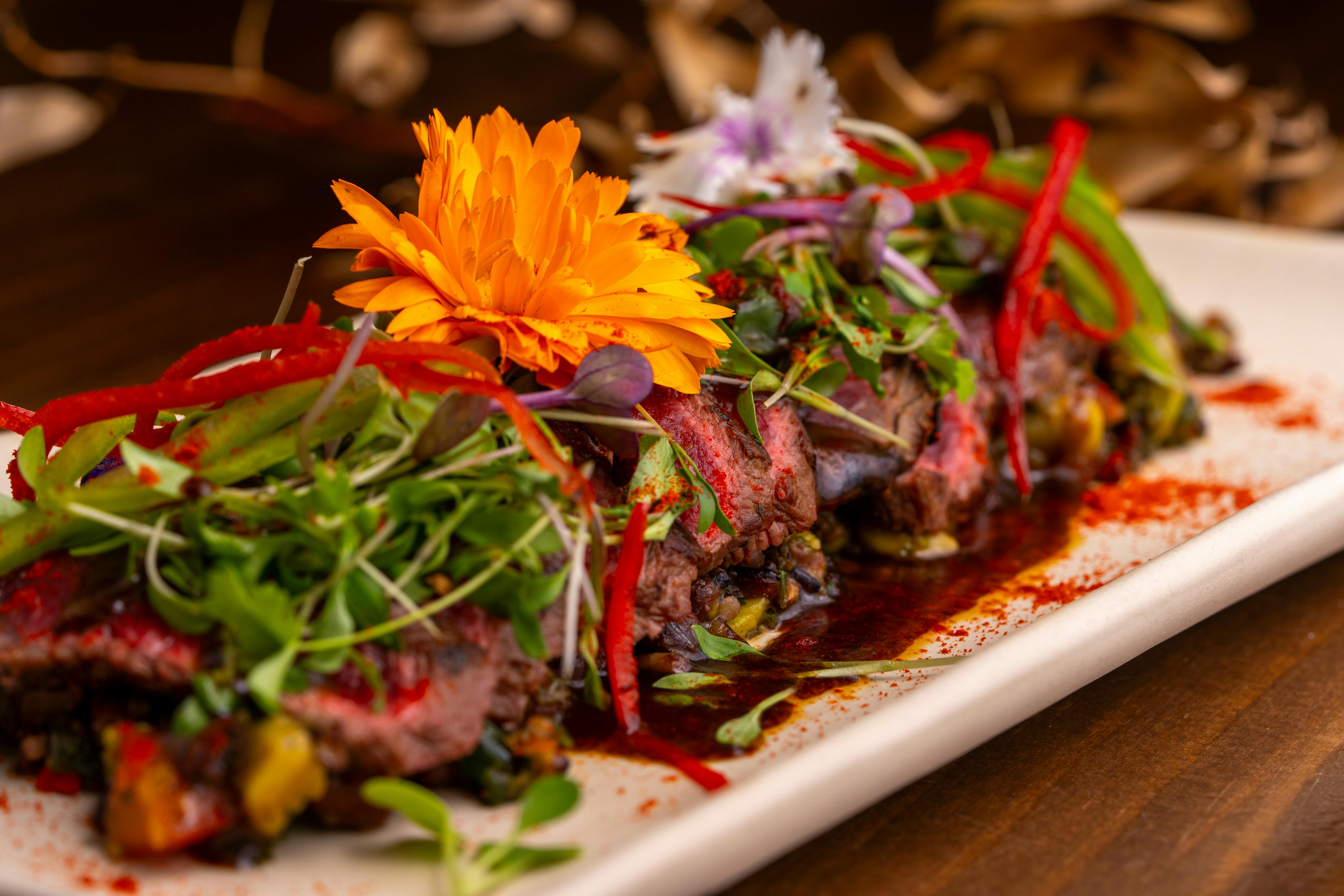 Gourmet Steak Dish with Edible Flowers · Free Stock Photo